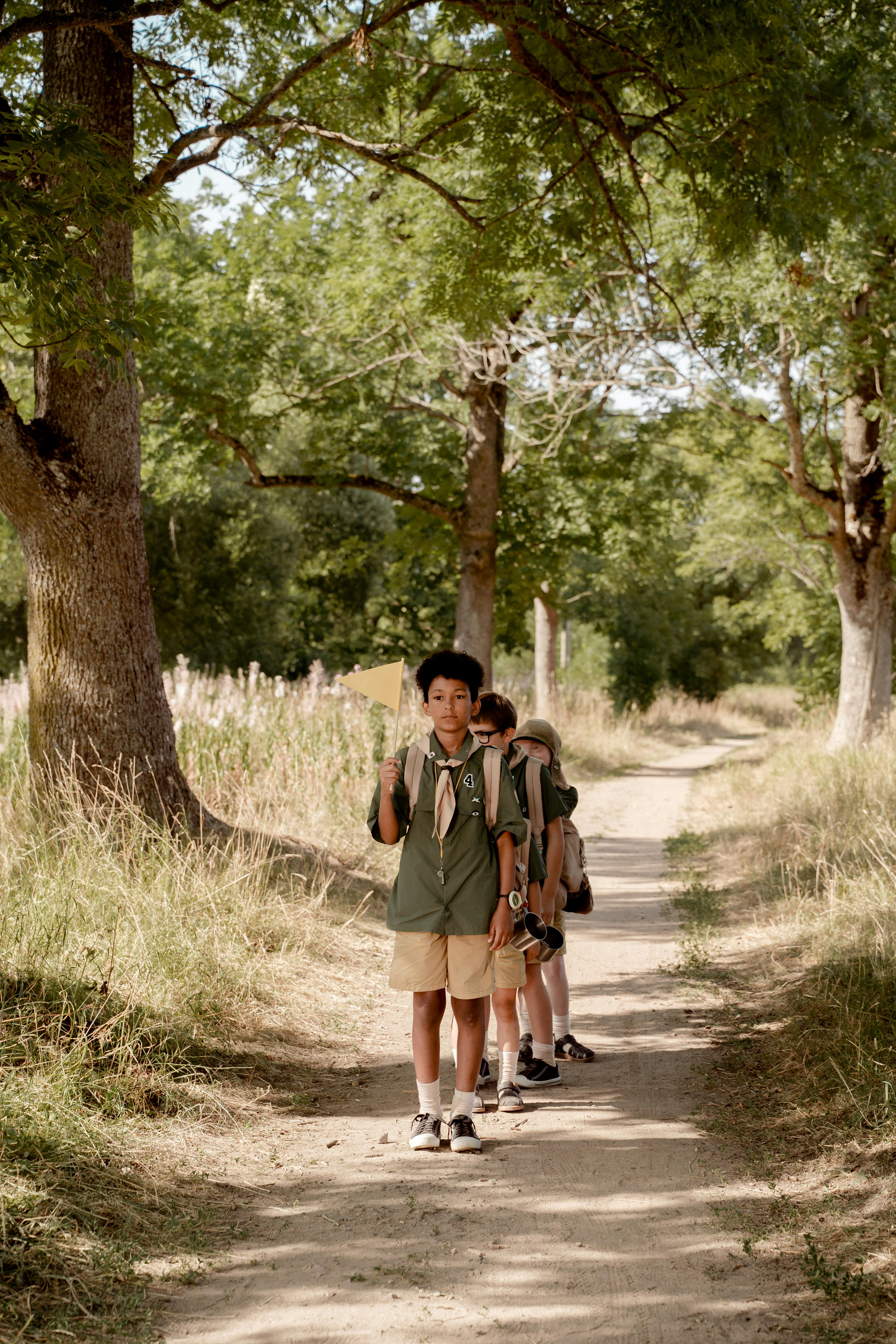 Leader of Scouts Holding Yellow Pennant · Free Stock Photo