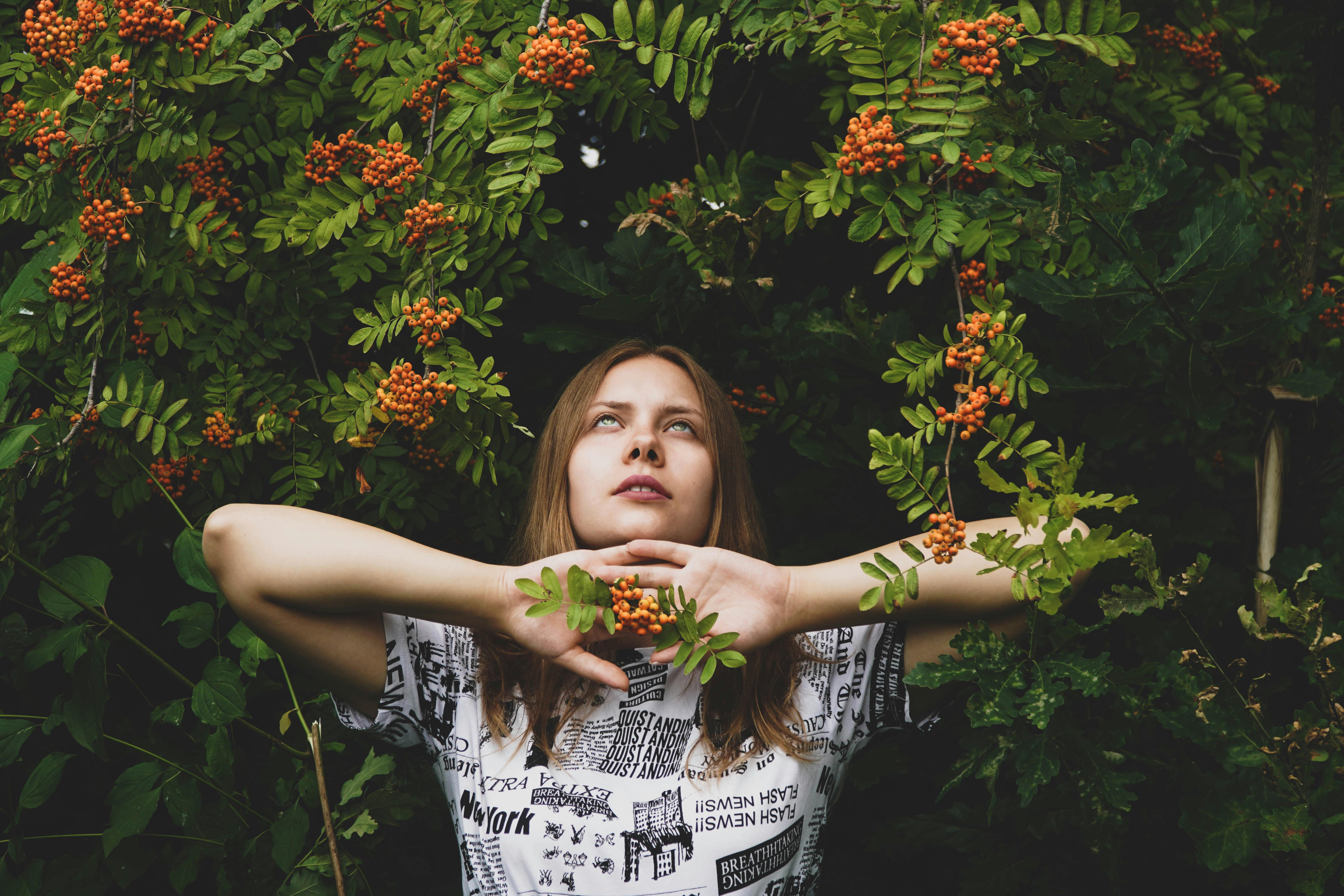 Woman Standing between Trees in Mountains · Free Stock Photo