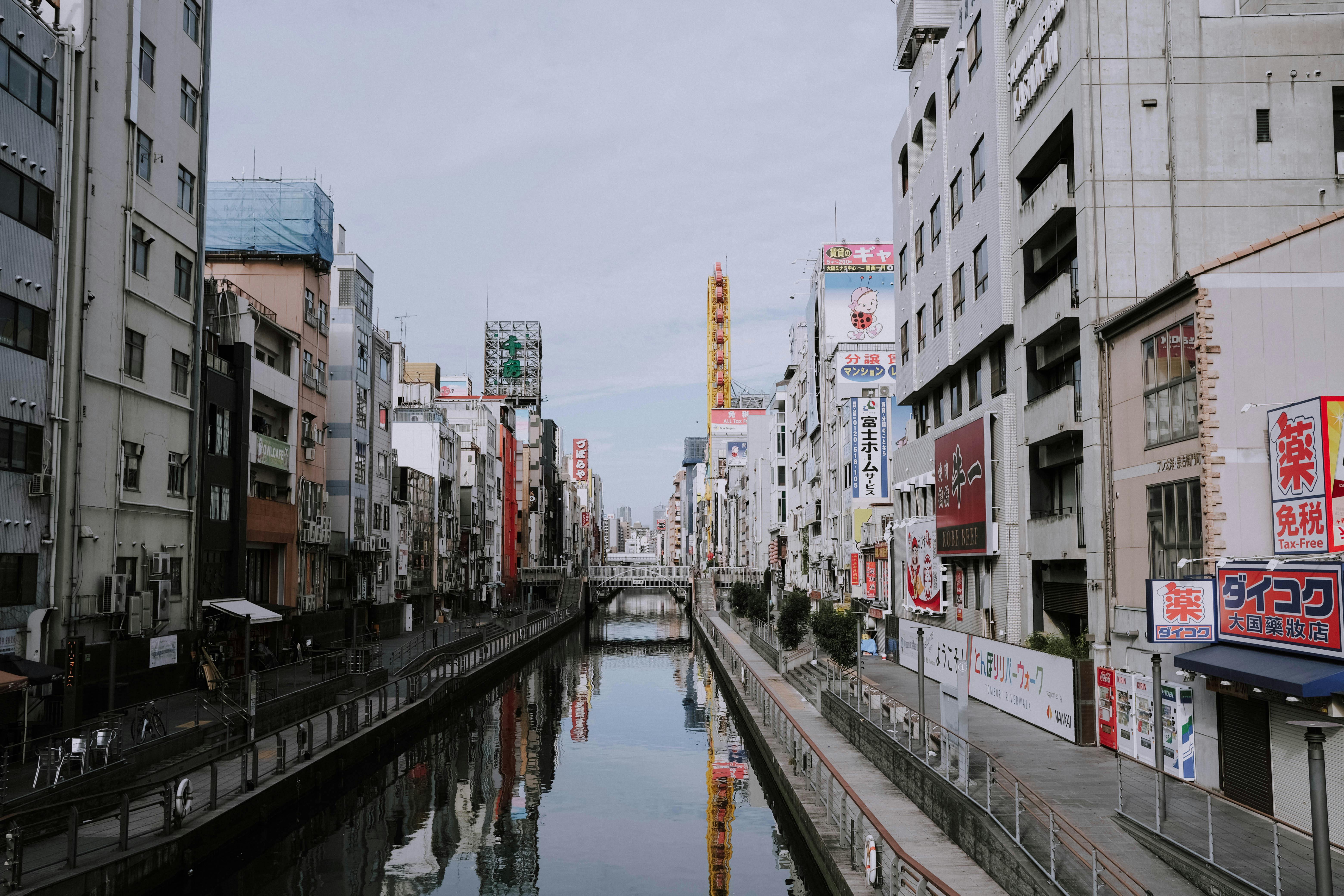 River Between Concrete Buildings · Free Stock Photo