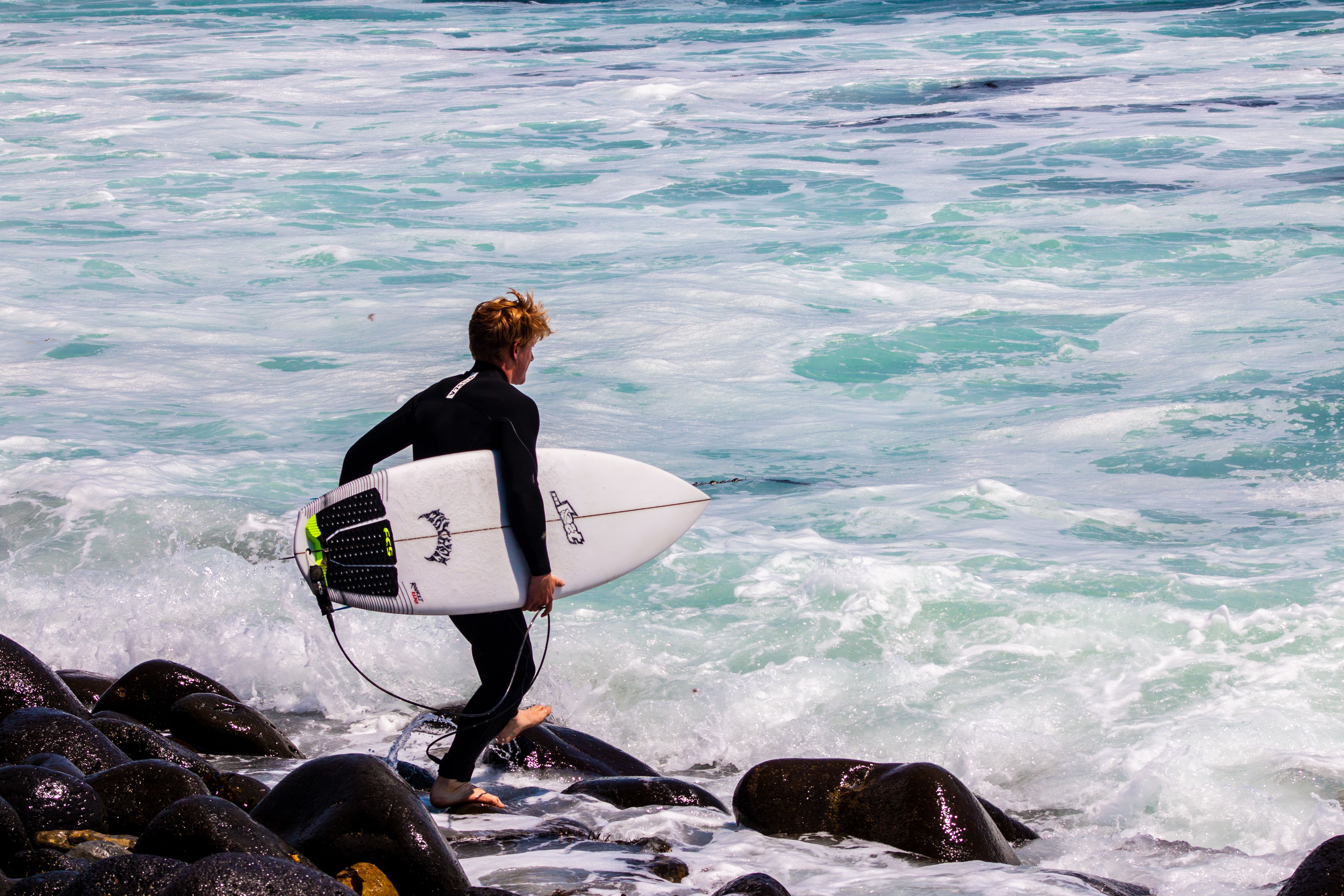 A Surfer Carrying a Surfboard · Free Stock Photo