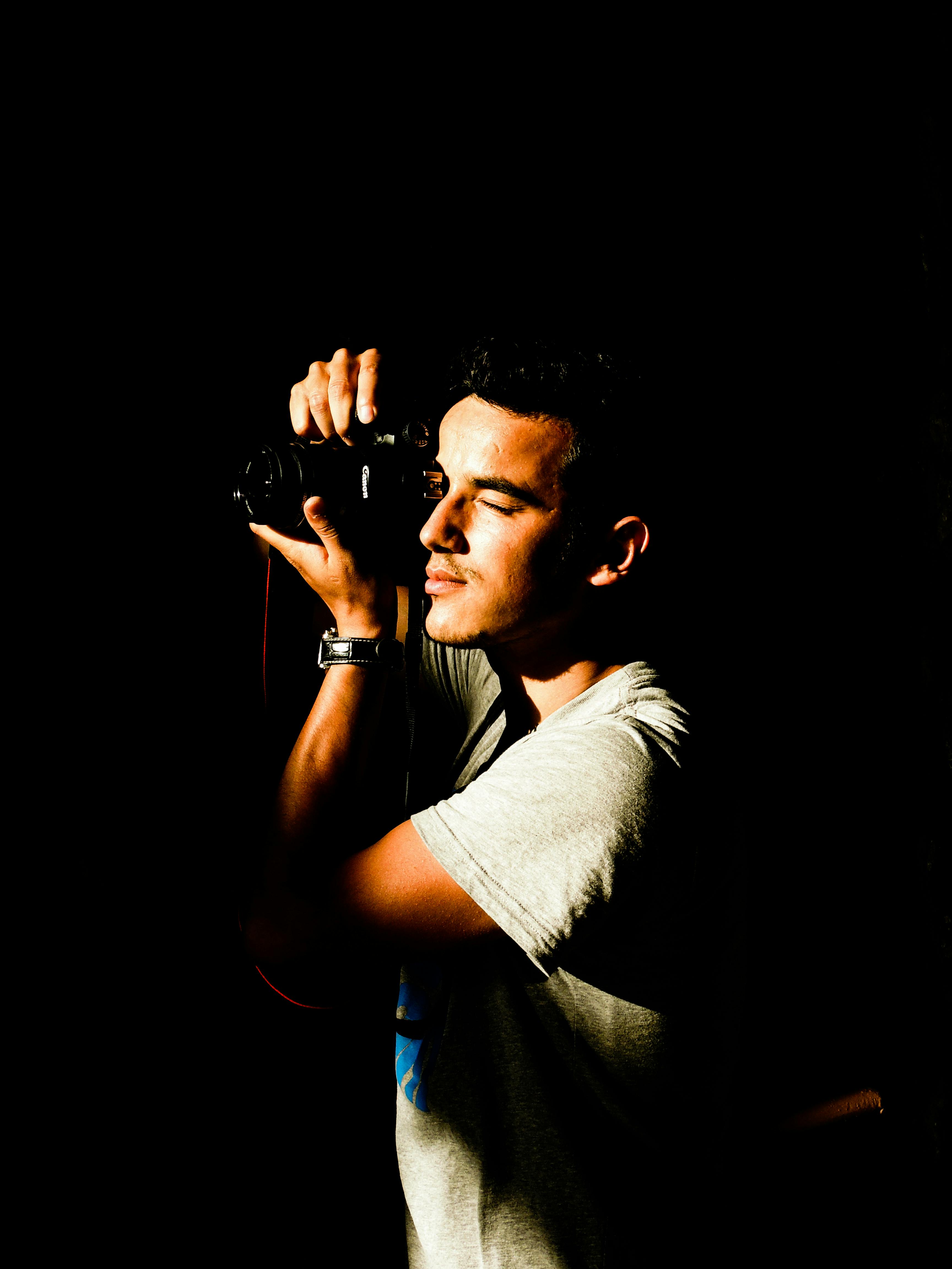 Man Carrying Cameras · Free Stock Photo