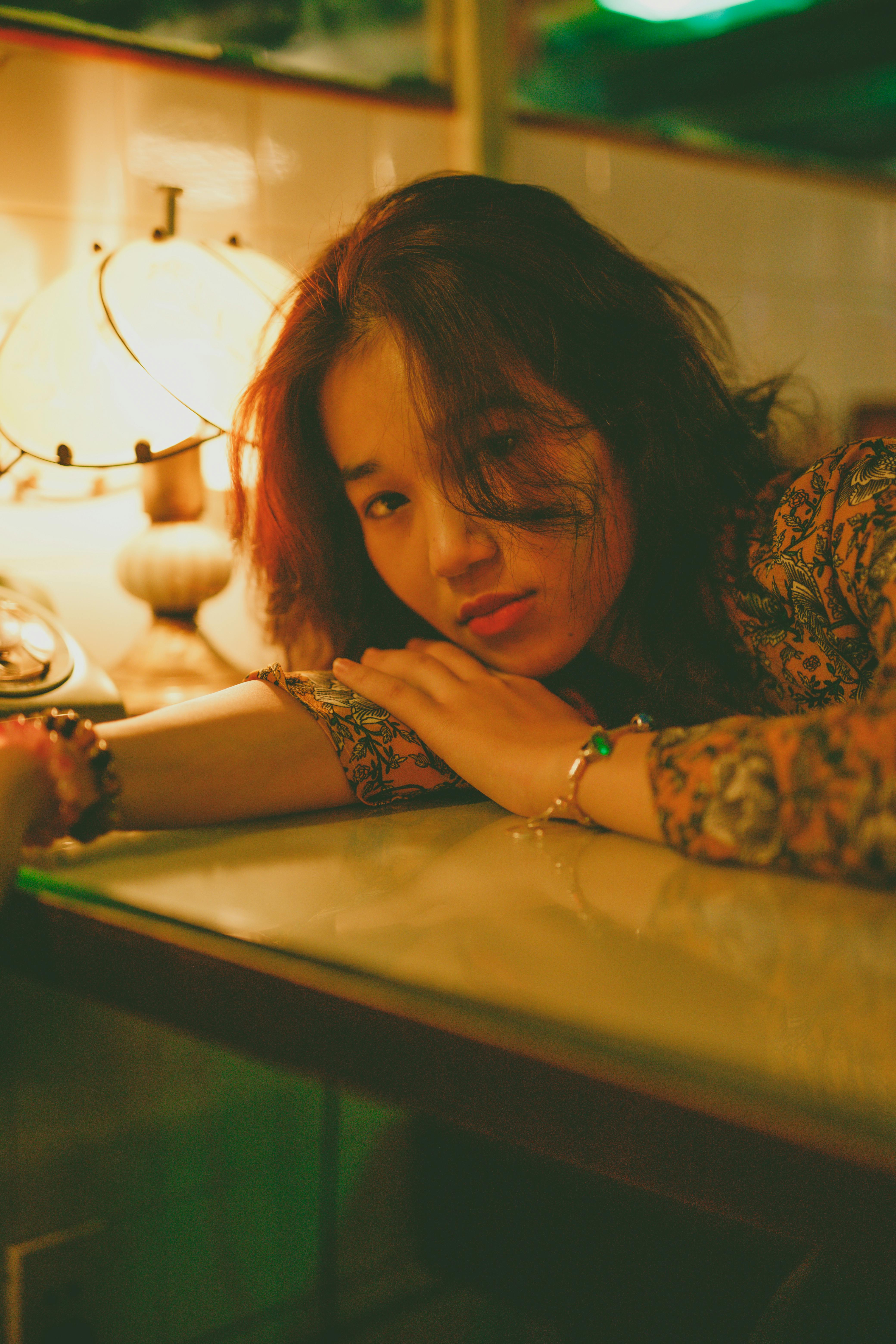 A Woman Leaning on a Table · Free Stock Photo