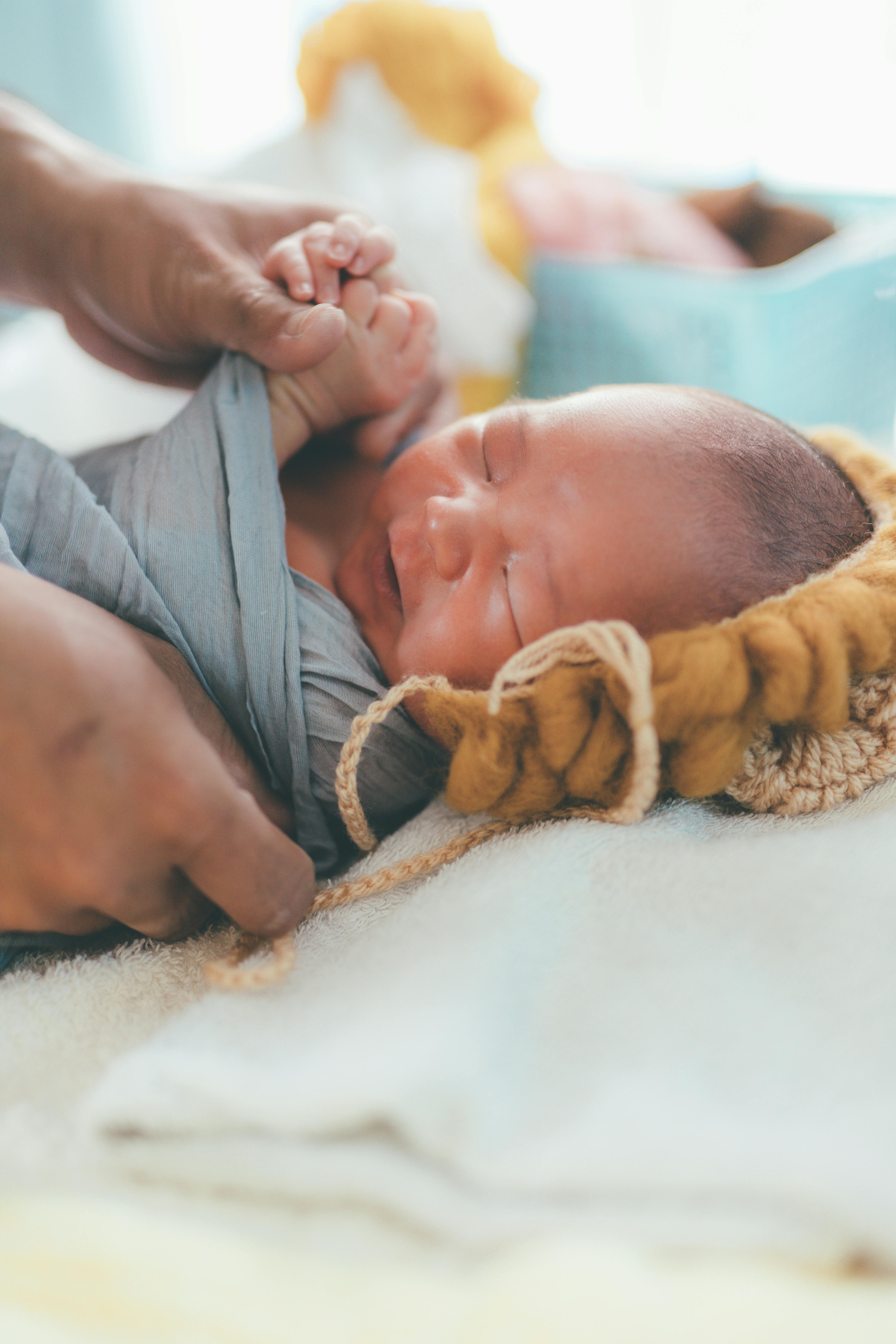 A Baby Getting Wrapped with a Blanket · Free Stock Photo