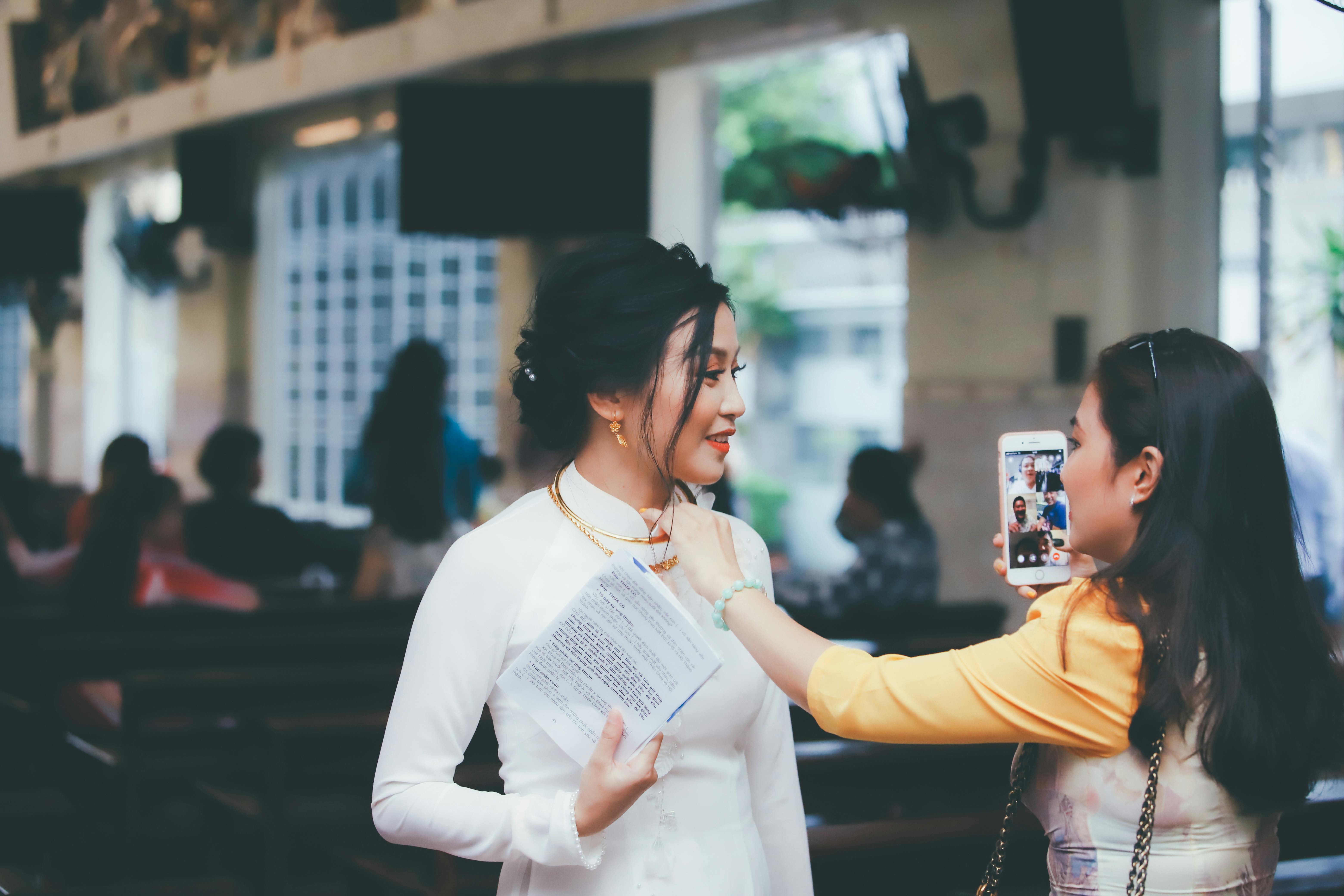 A Woman Recording Herself with a Smartphone · Free Stock Photo