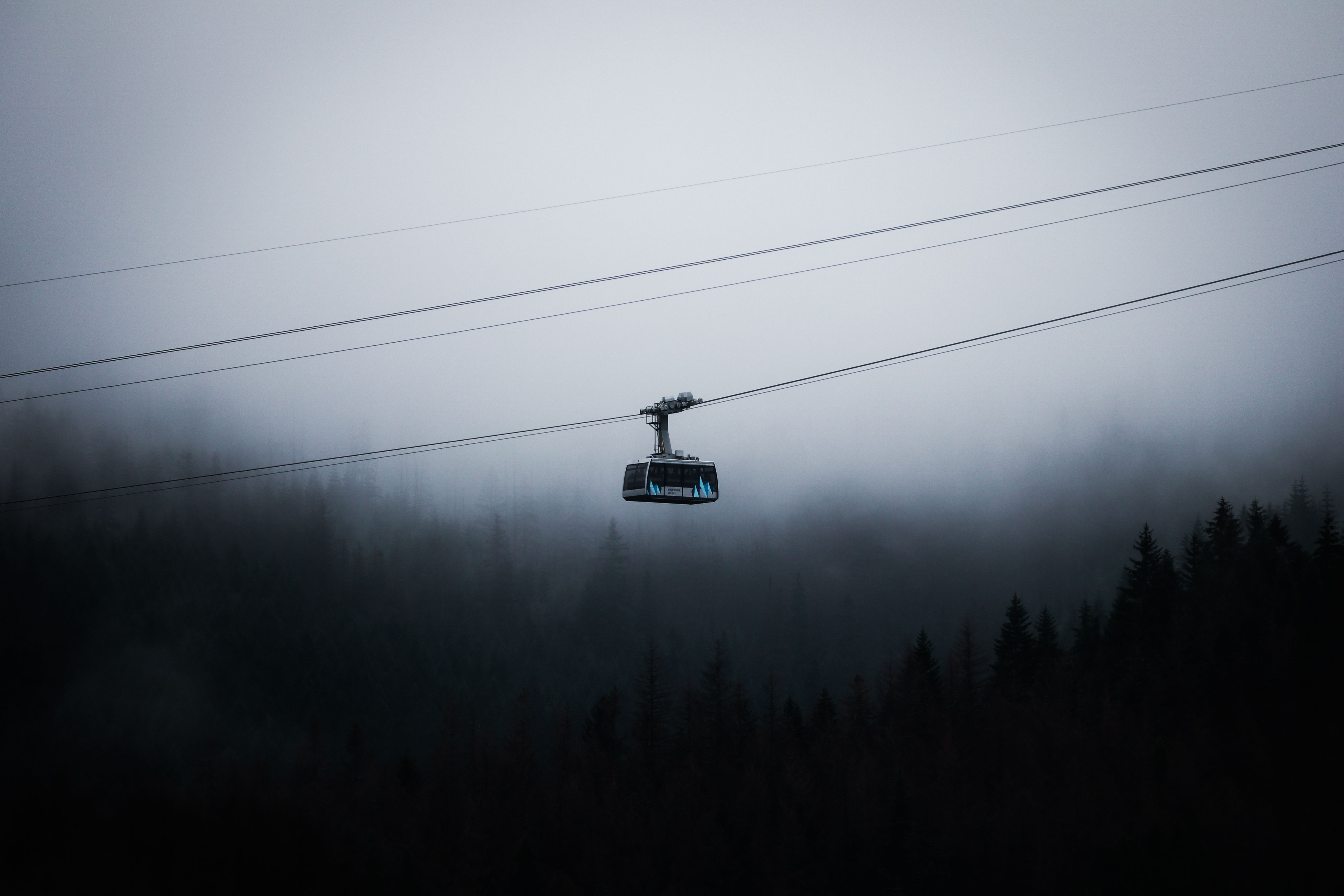 Cable Car Passing over a Foggy Forest · Free Stock Photo