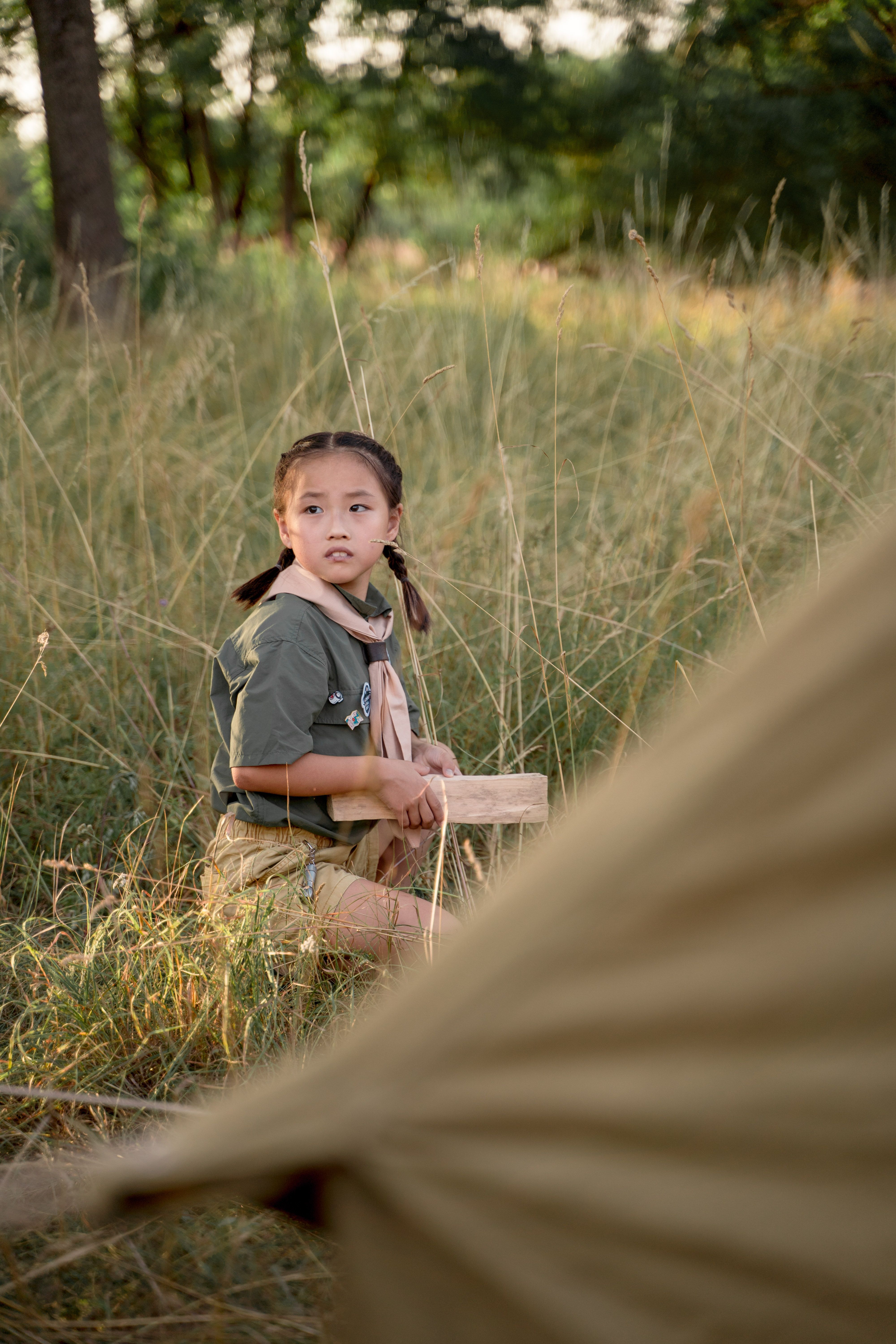 Girl Sitting on Grass Field · Free Stock Photo
