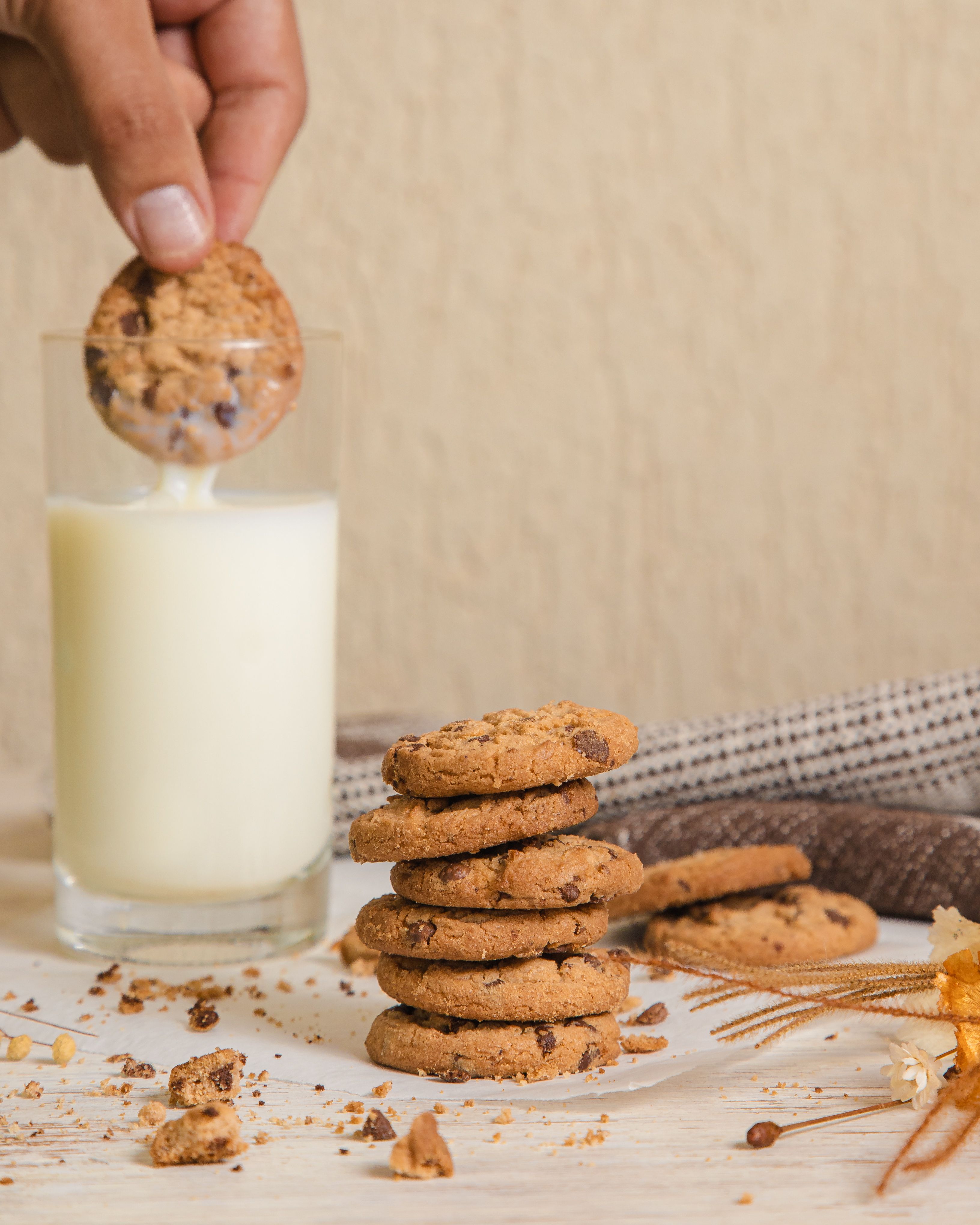 Person Dipping a Cookie in a Milk · Free Stock Photo