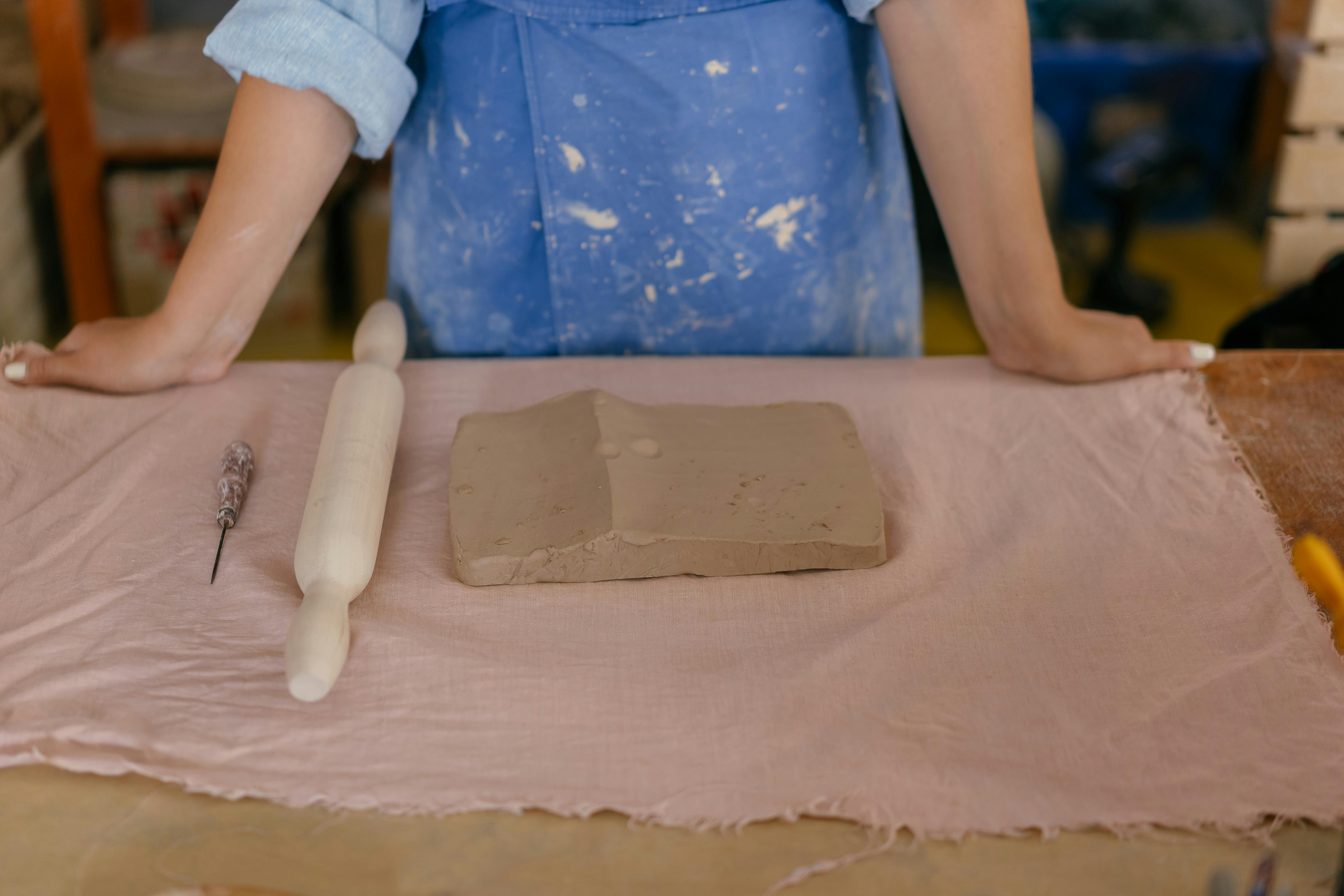 A Rolling Pin Beside the Brown Clay · Free Stock Photo