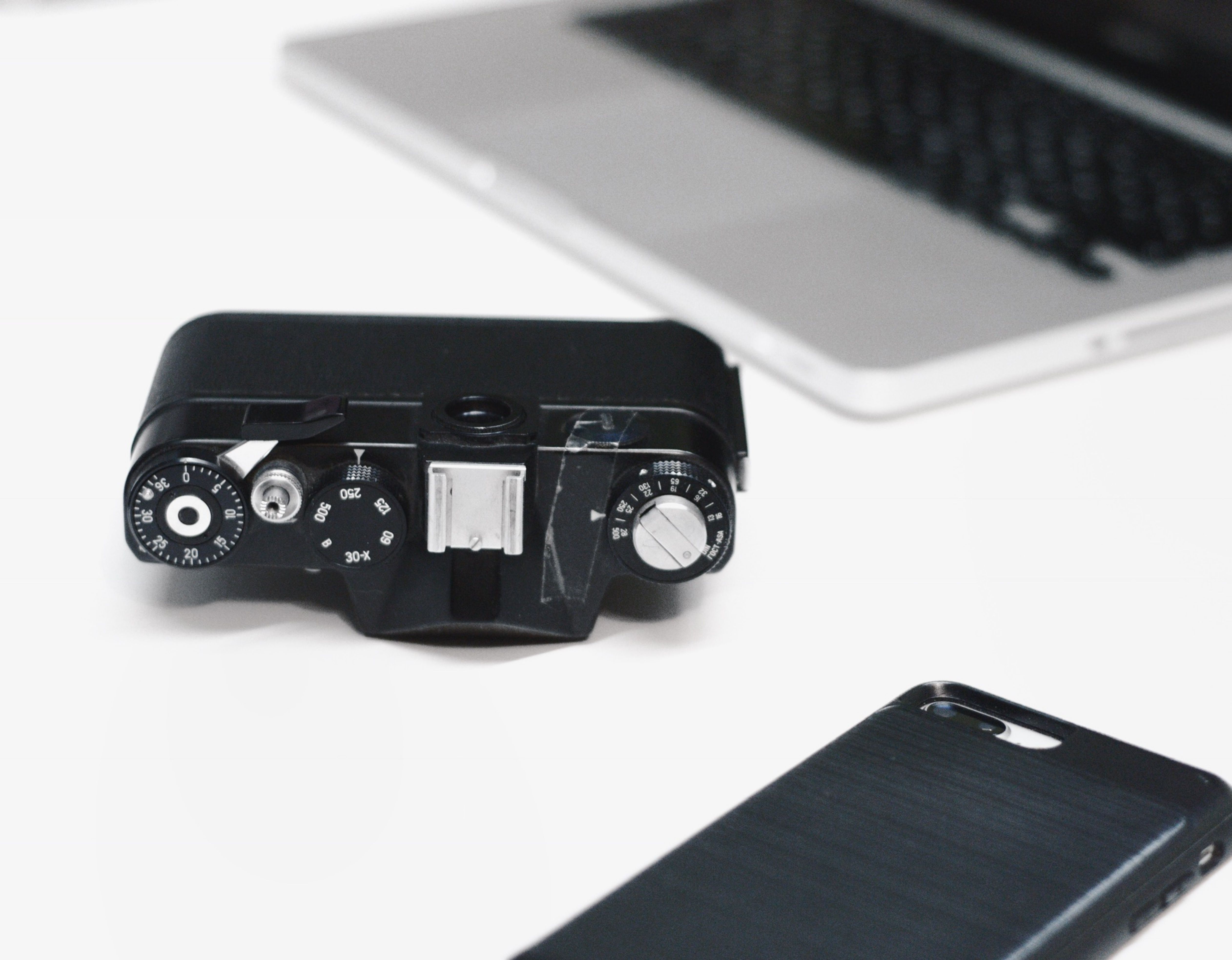 A Black Cell Phone on a Laptop · Free Stock Photo