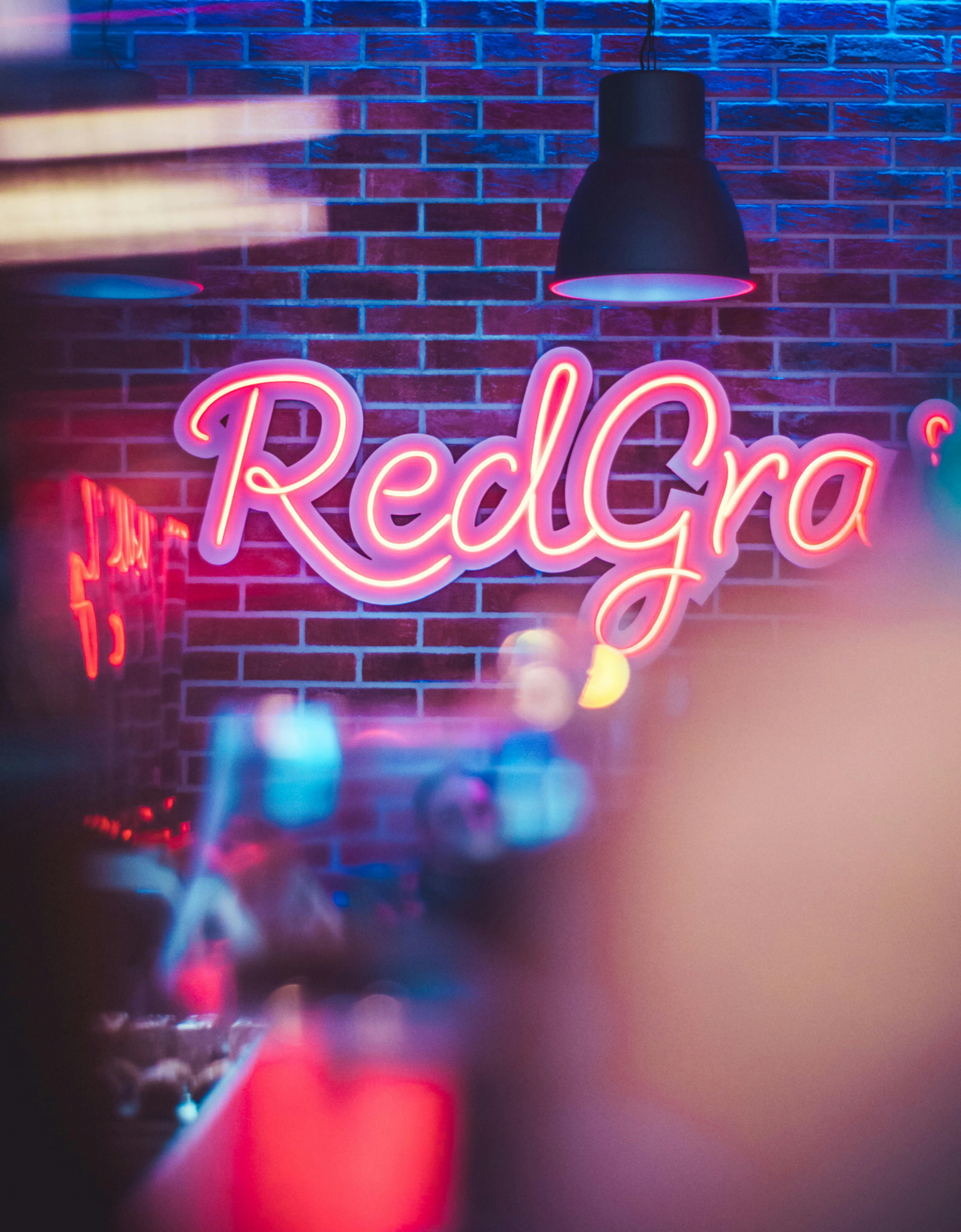 Neon Signage on Brown Brick Wall · Free Stock Photo