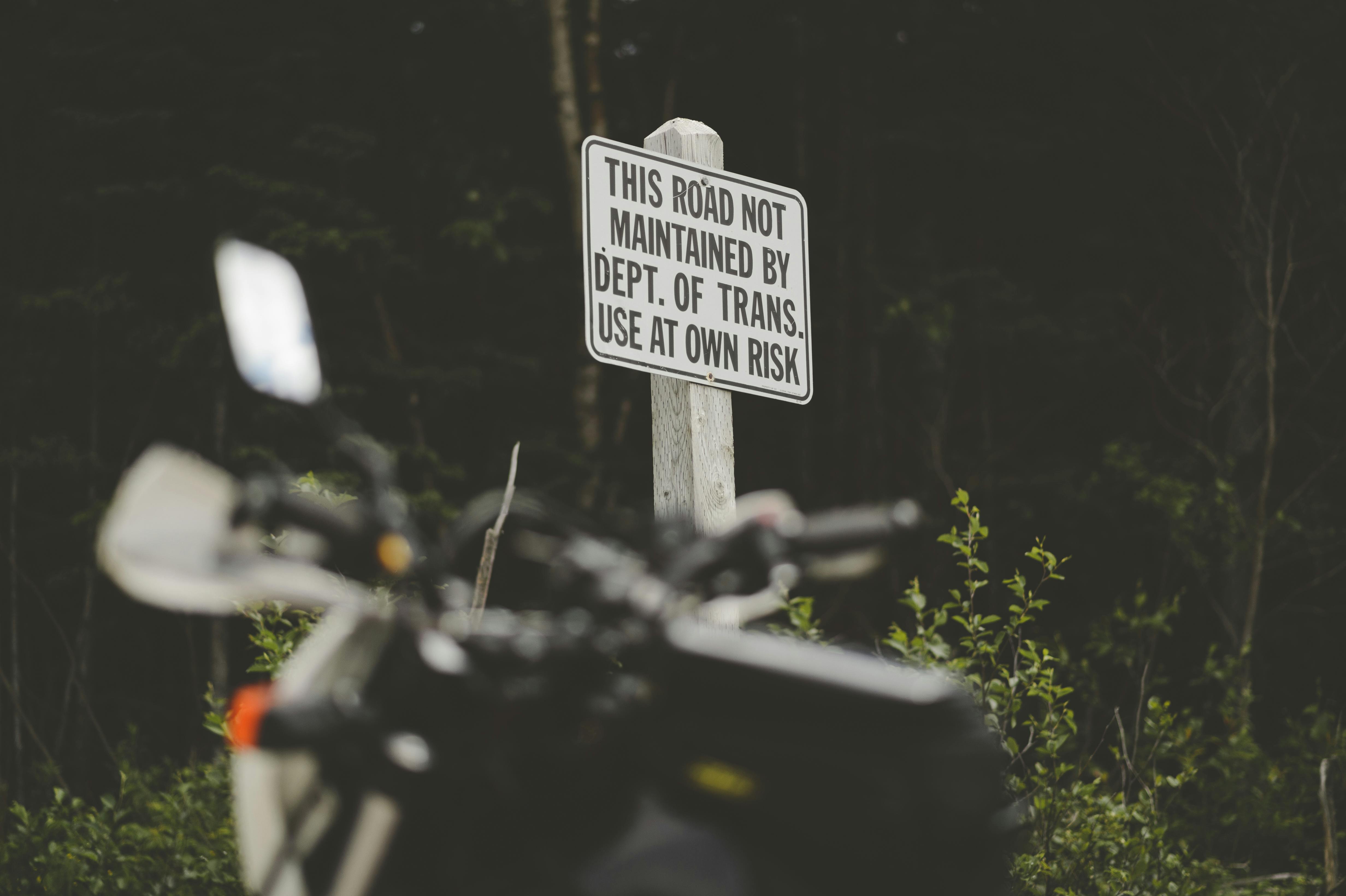 Road Information Sign over a Motorbike · Free Stock Photo