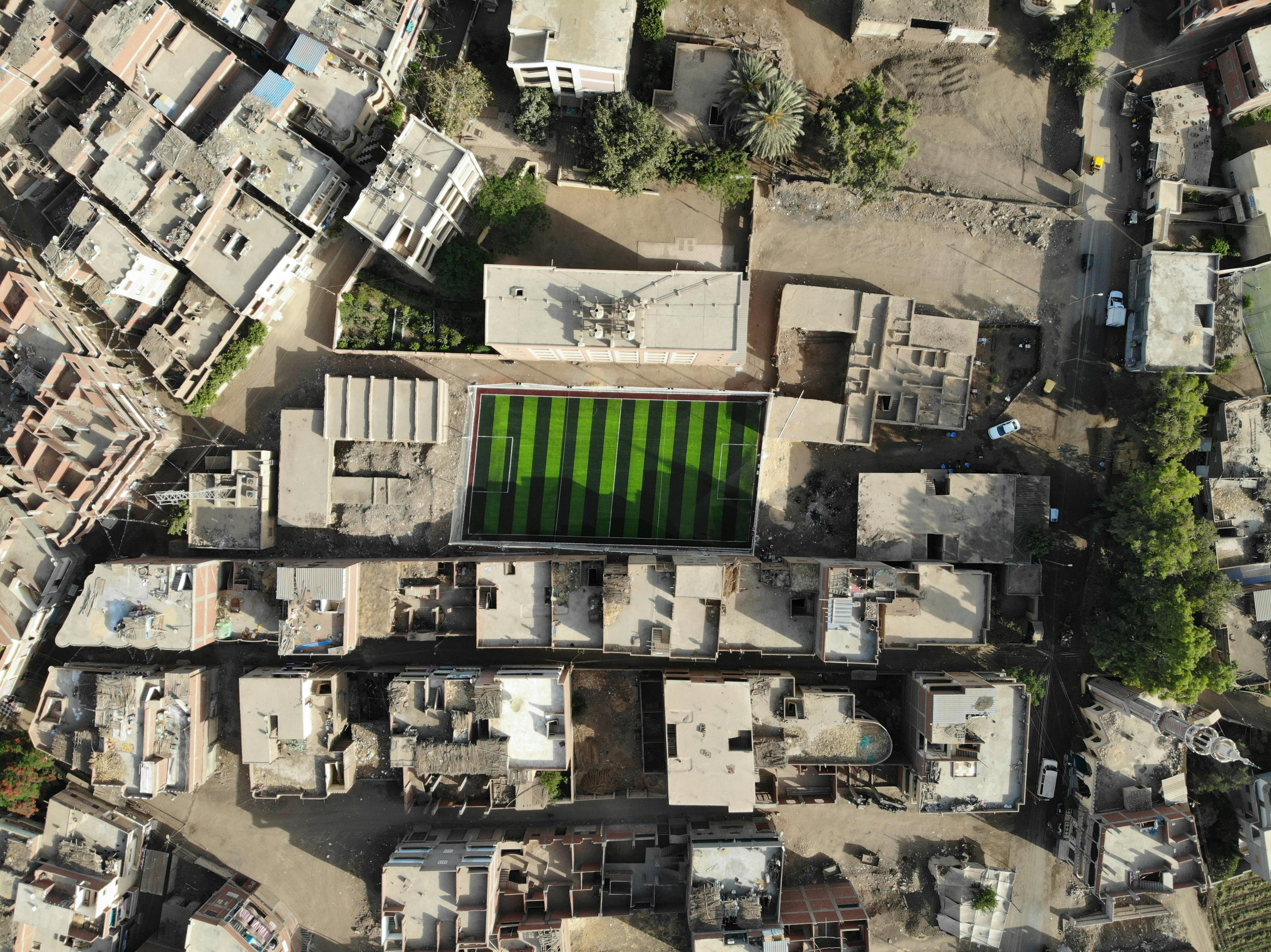 Aerial View of Football Field surrounded with Shabby Buildings · Free ...
