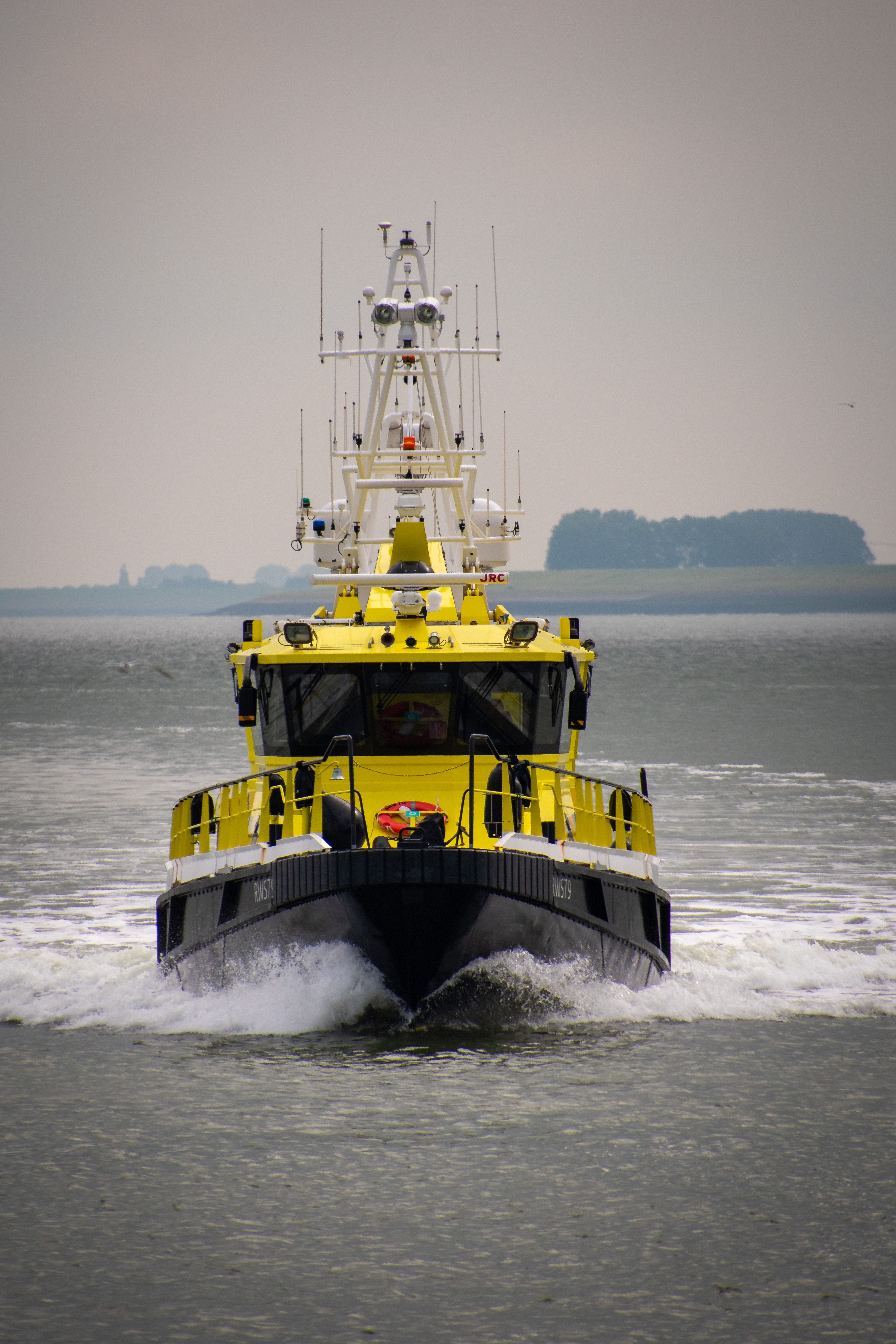 Yellow and Black Boat on Sea under Gloomy Sky · Free Stock Photo
