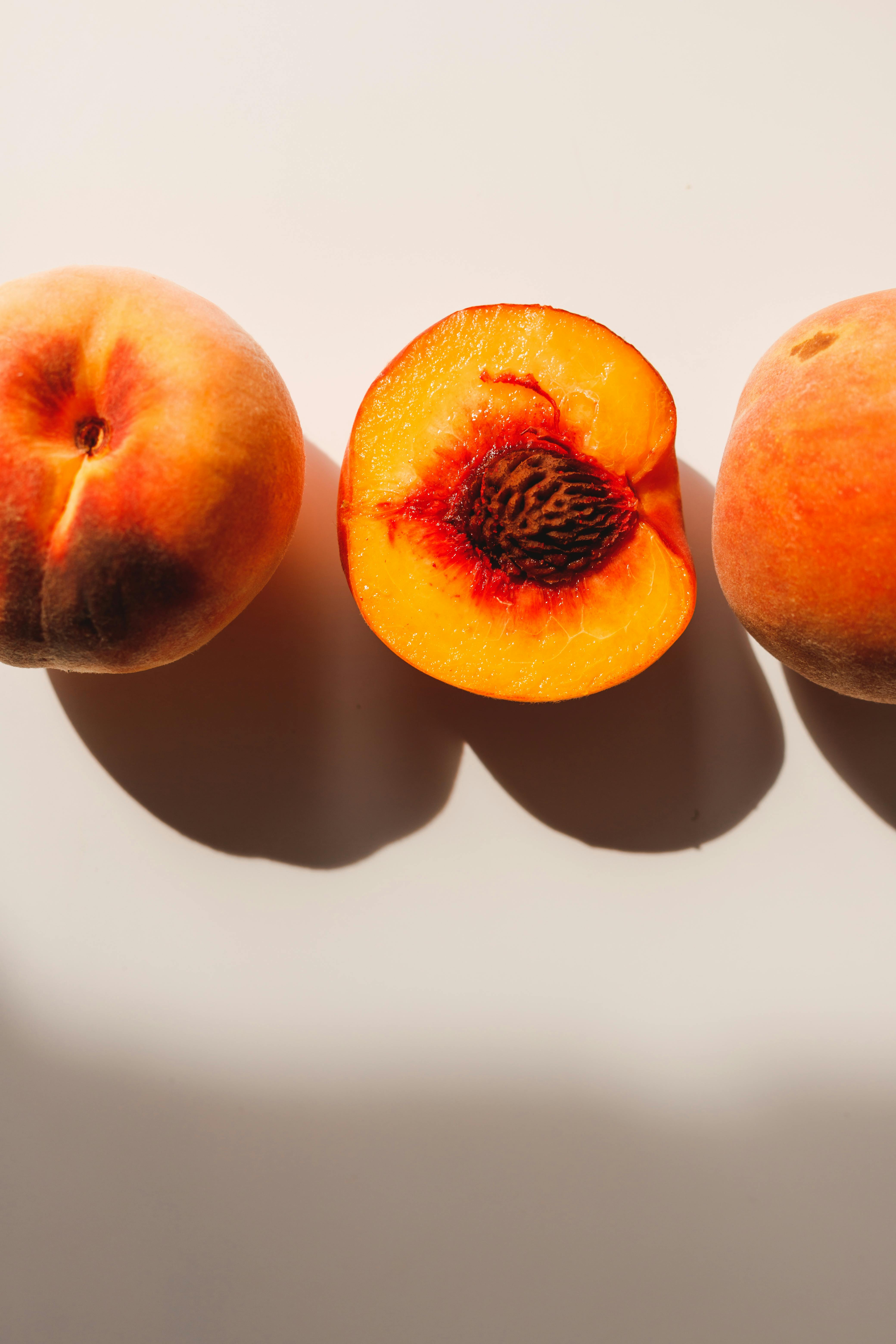 A Close-Up Shot of a Peach on a Book · Free Stock Photo