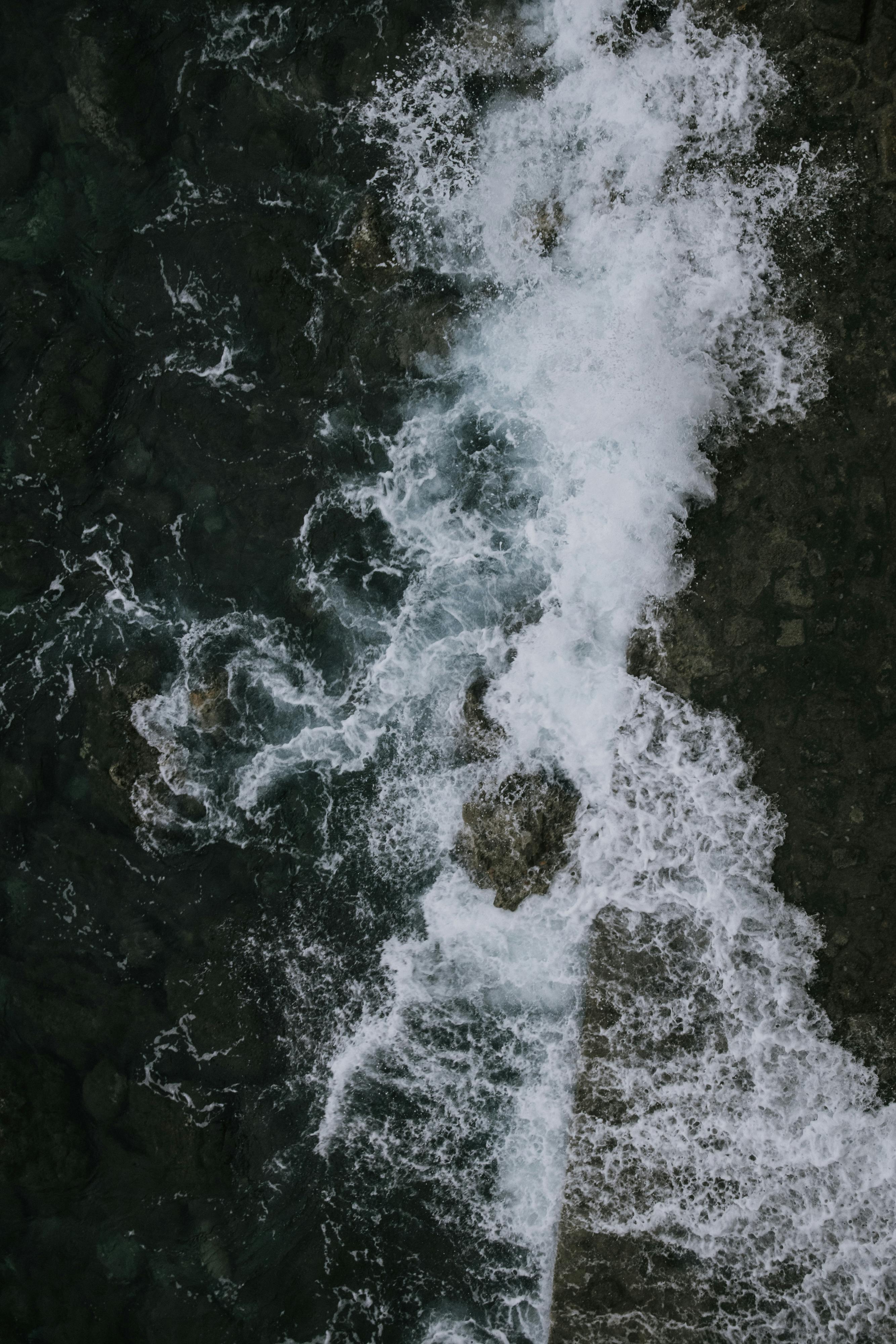 Aerial Shot of Ocean Waves Hitting the Rocks · Free Stock Photo