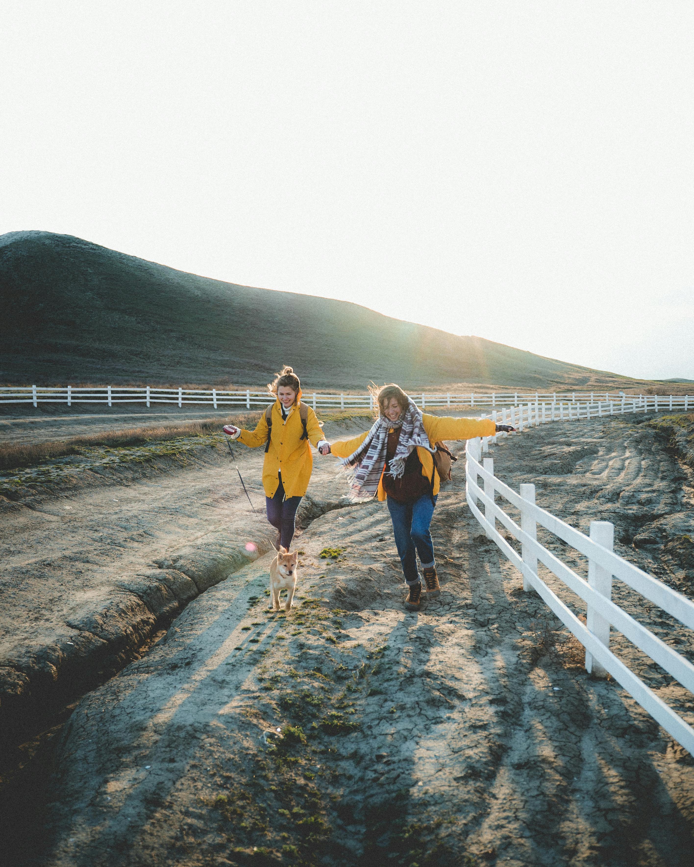 Person Walking on Green Grass Field · Free Stock Photo