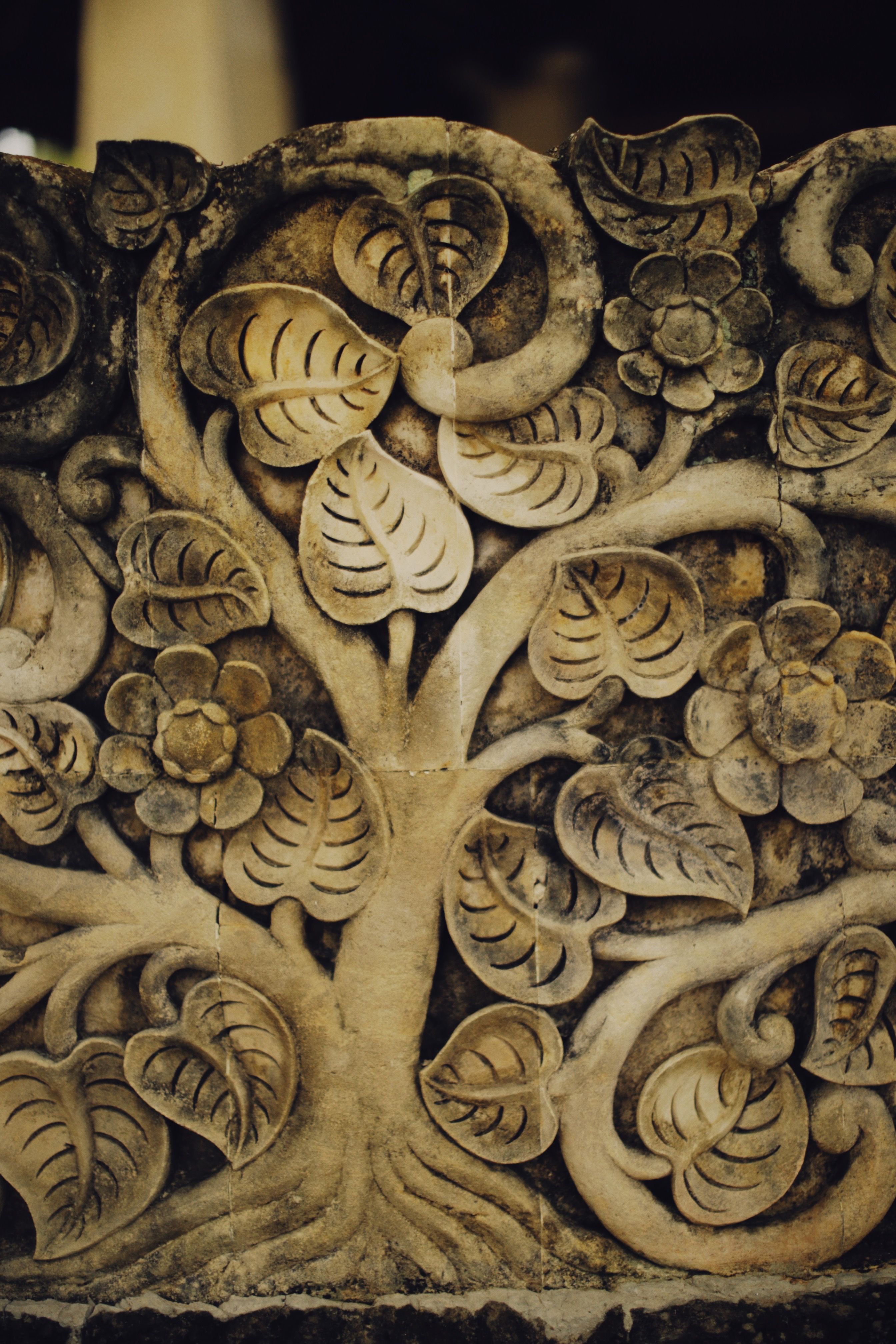 Intricate Carved Stone Panel of Ancient Figure · Free Stock Photo