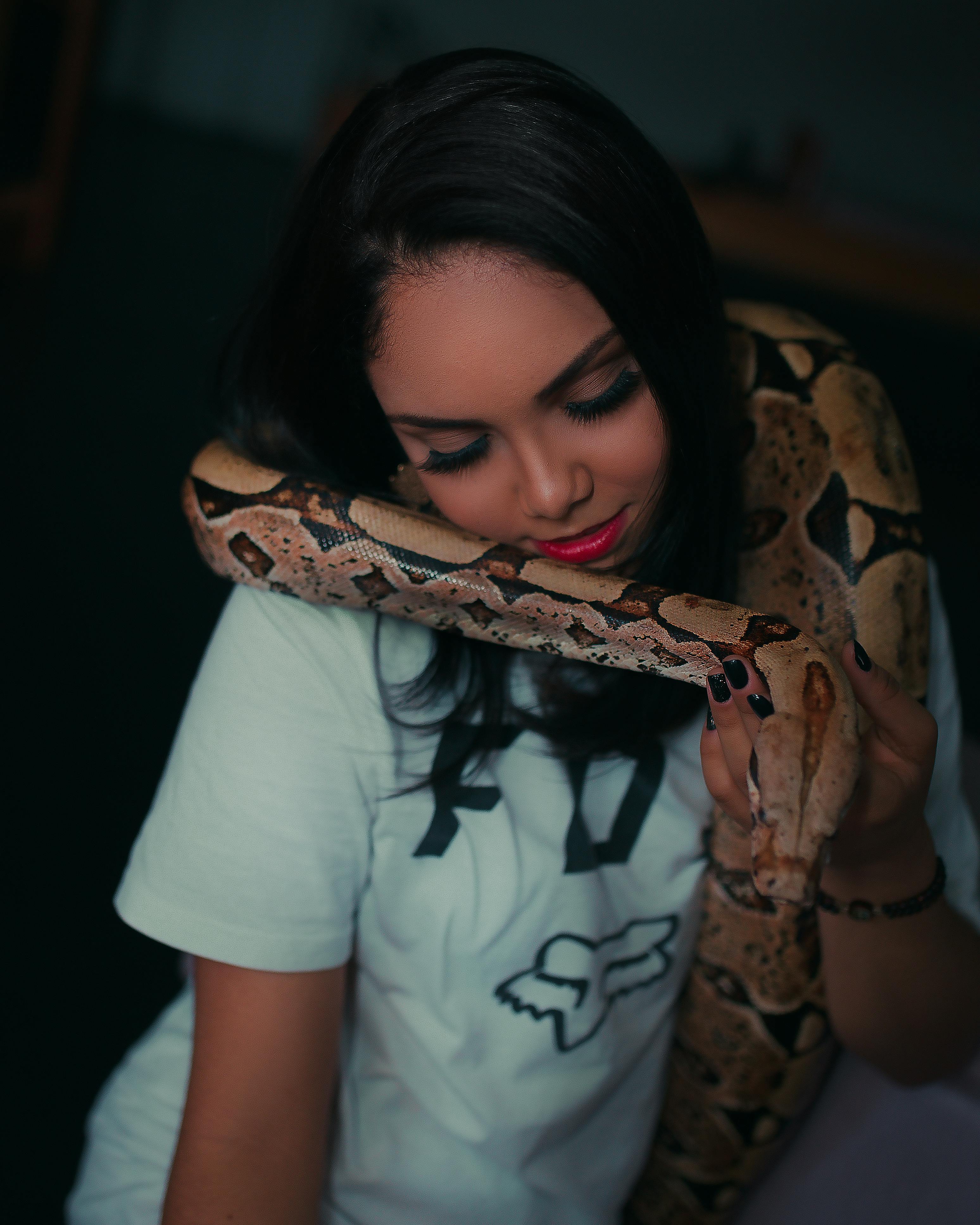 A Woman Posing with a Python Wrapped around Her Neck · Free Stock Photo