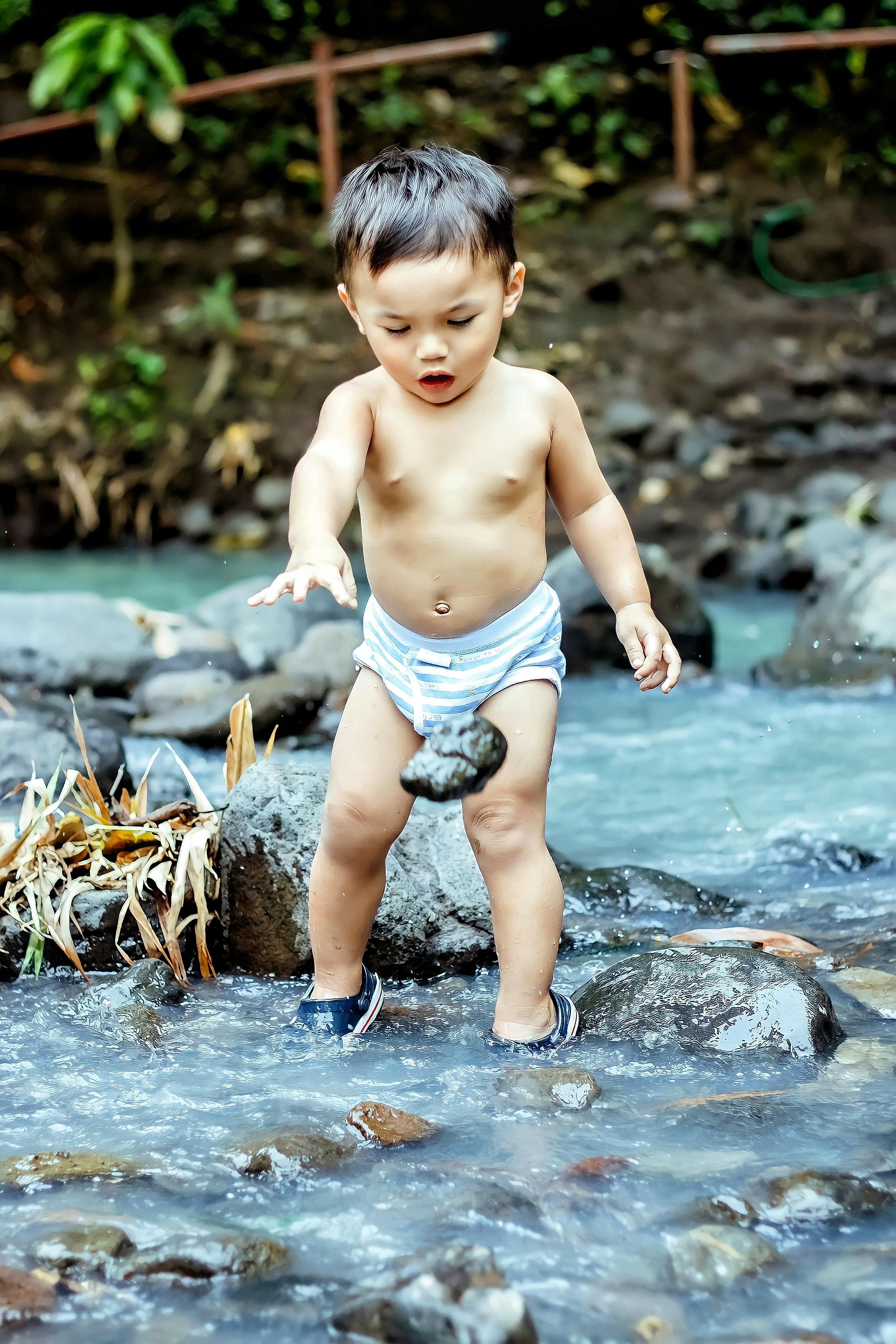 Photo of a Child Throwing a Rock · Free Stock Photo