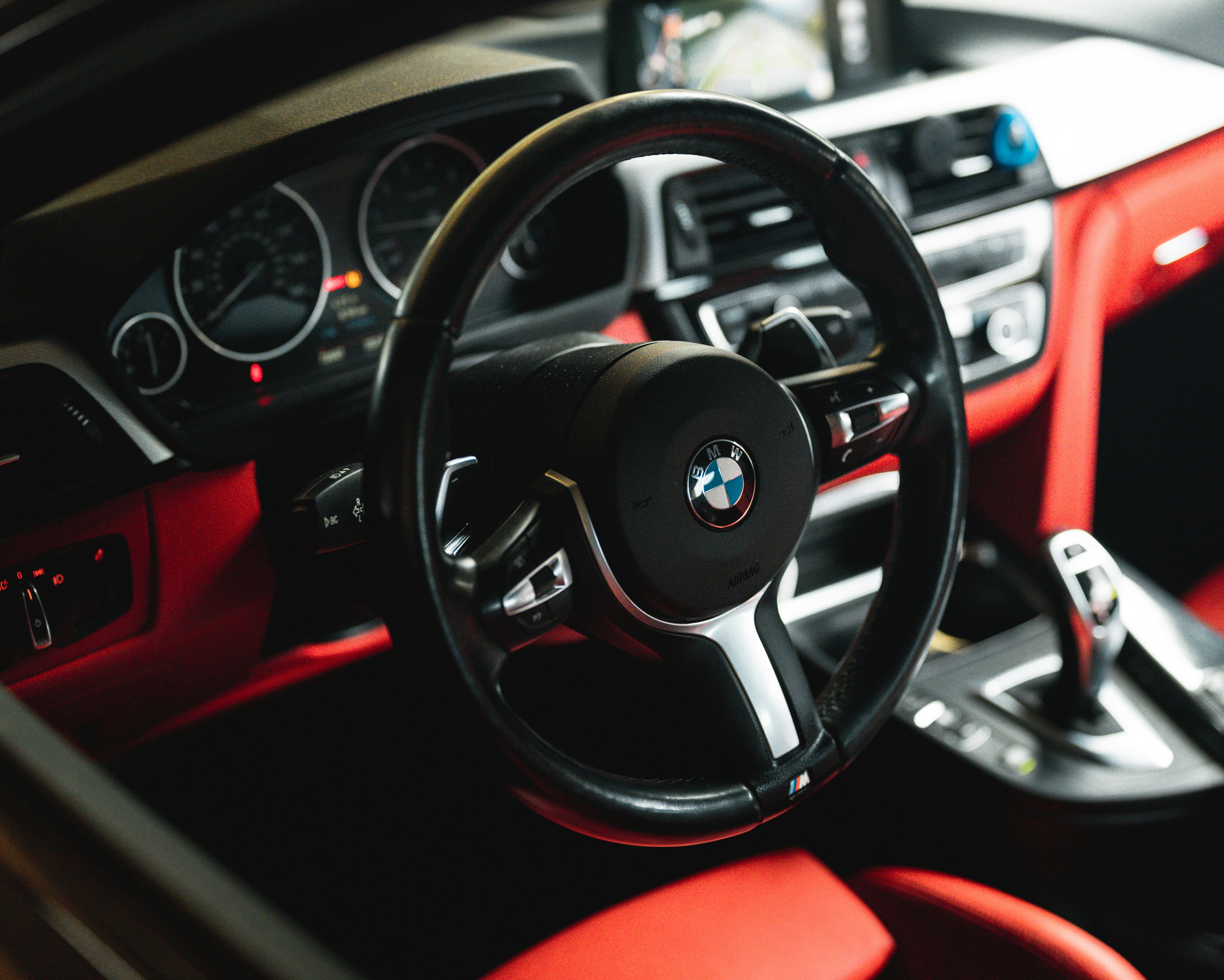 Person Holding Bmw Steering Wheel · Free Stock Photo