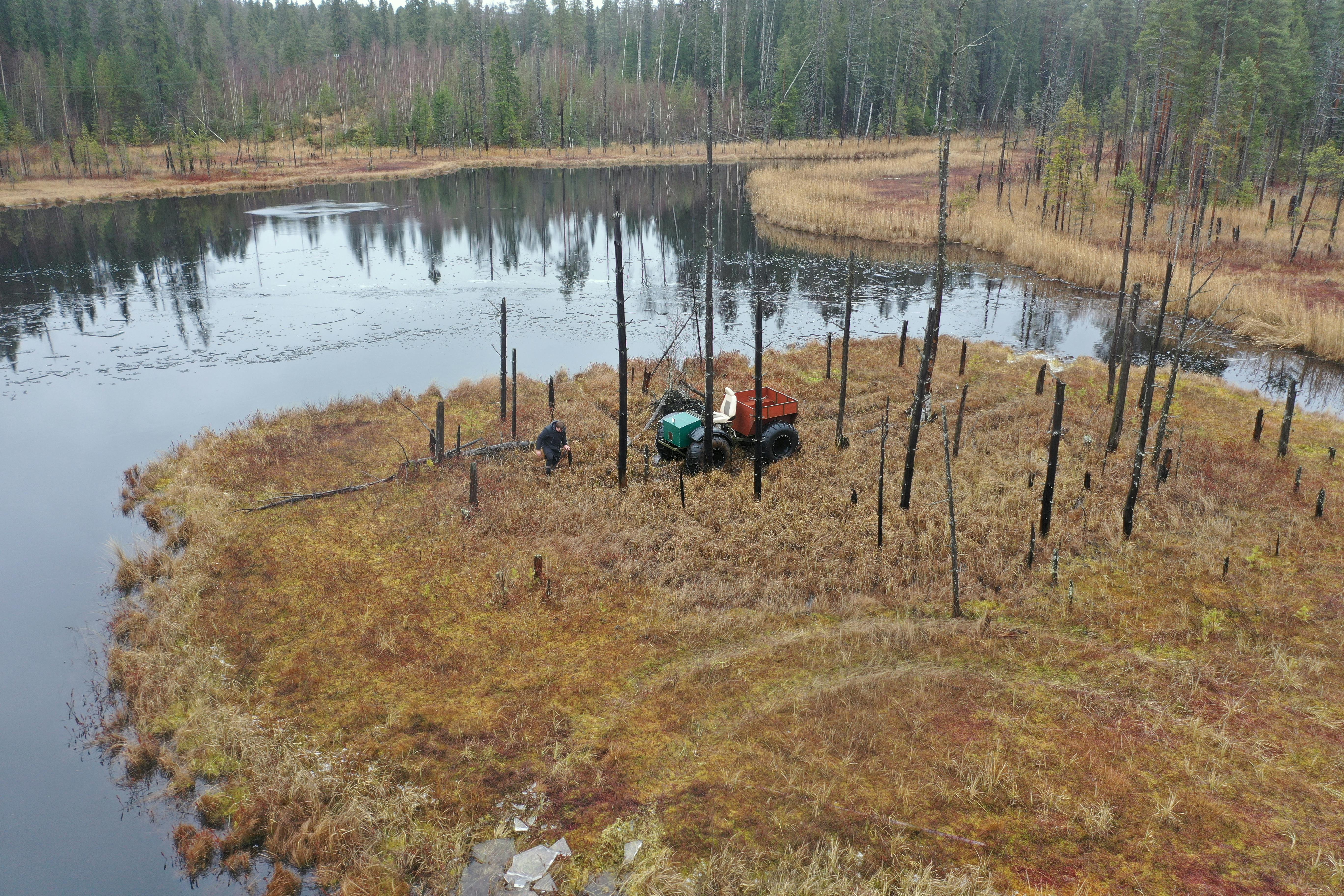 Man with vehicle on Islet in Lake · Free Stock Photo