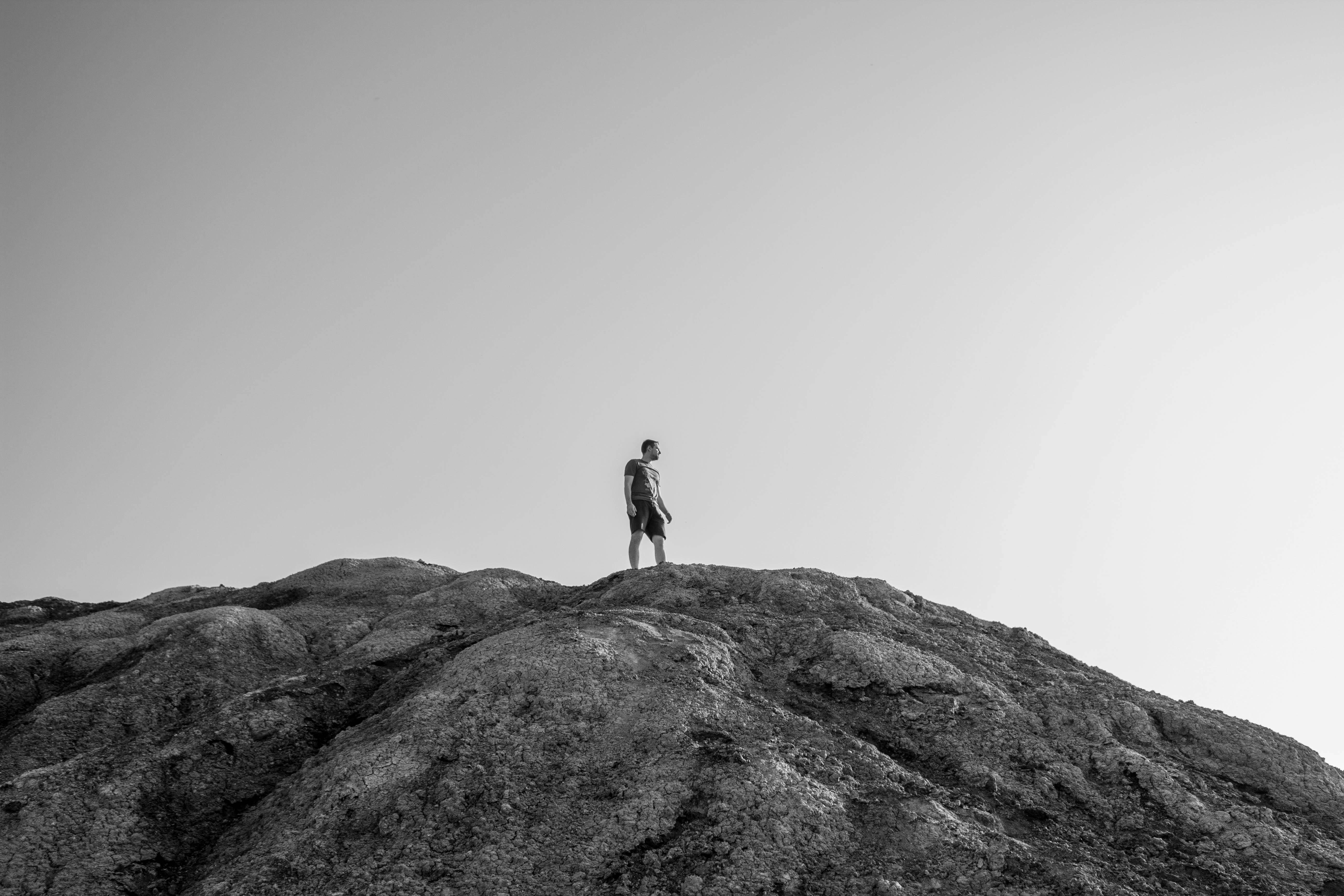 A Man Standing on a Rock Formation · Free Stock Photo