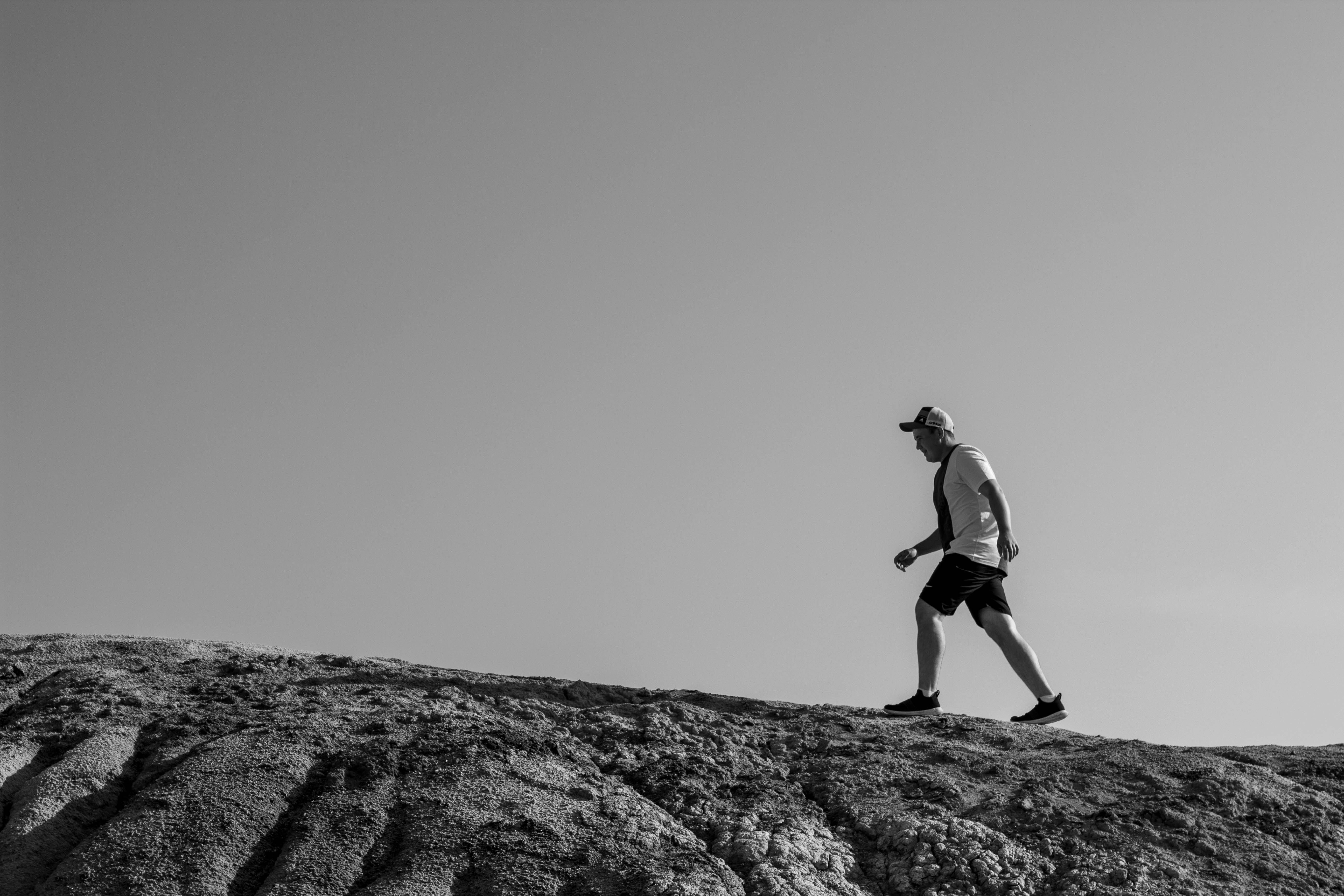 A Man Walking on a Rock Formation · Free Stock Photo