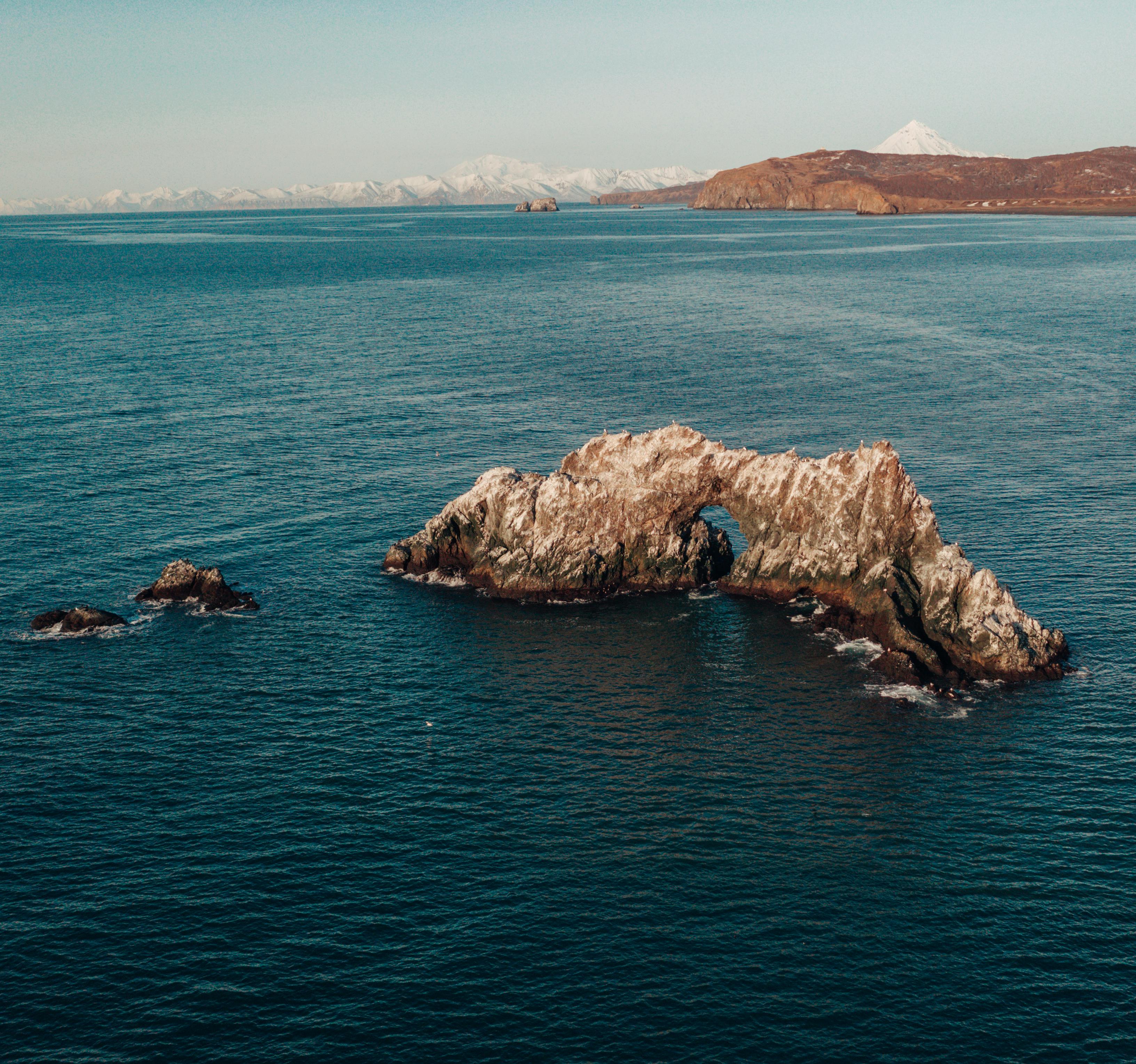 Rocky Island on the Middle of the Sea · Free Stock Photo