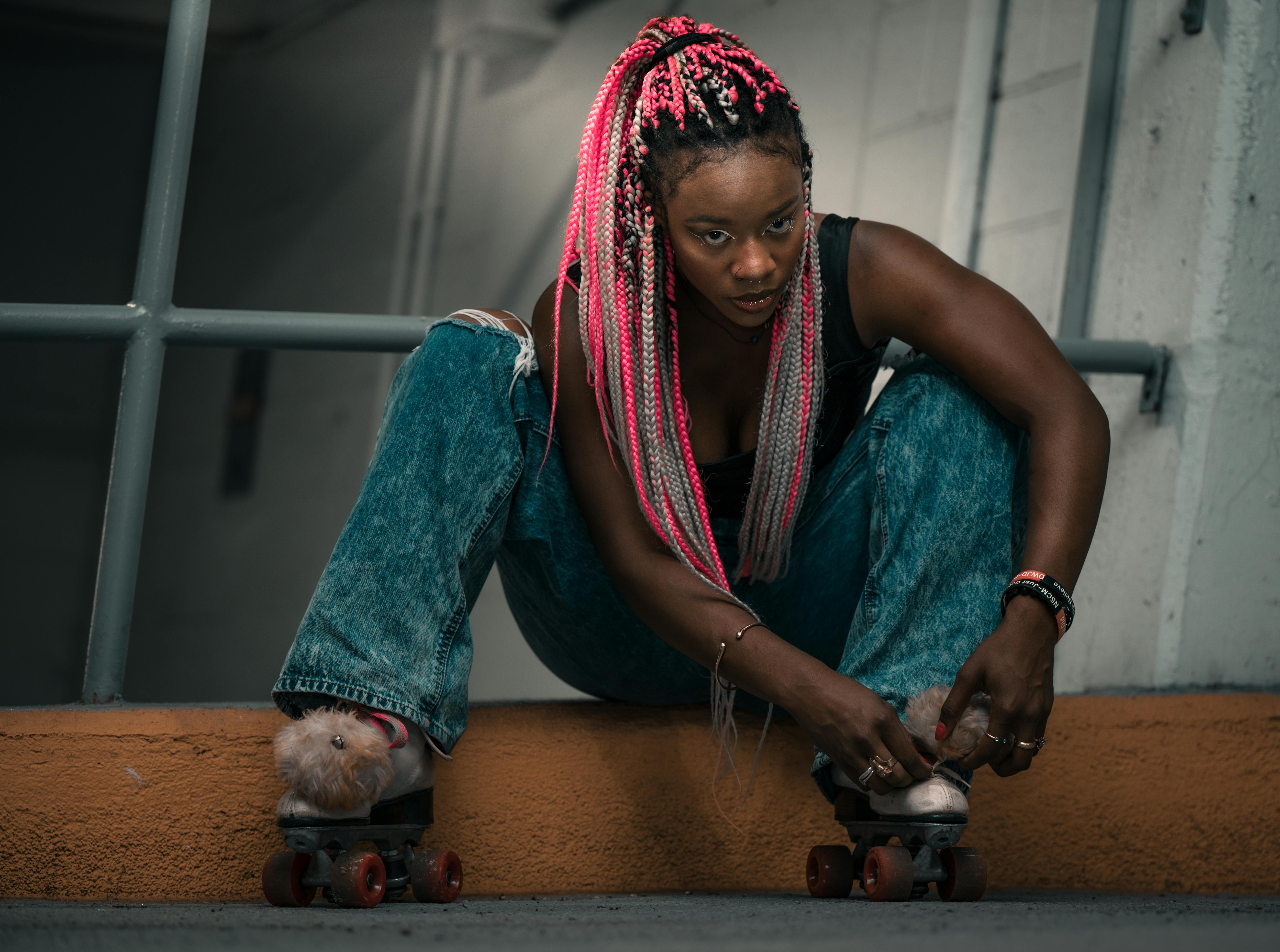 Woman Sitting on Handrail with Roller Skates · Free Stock Photo