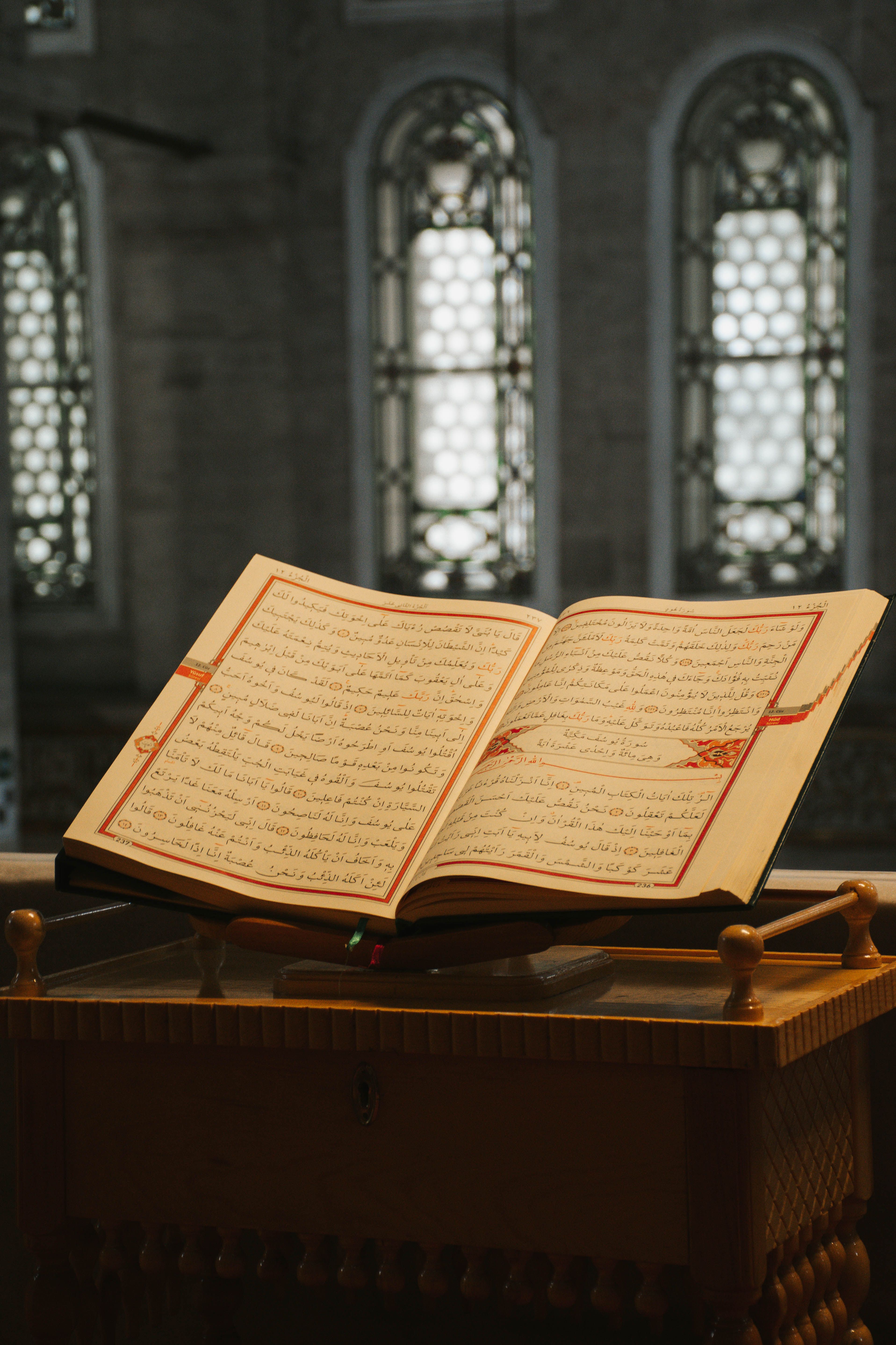 An Open Koran on a Wooden Table · Free Stock Photo