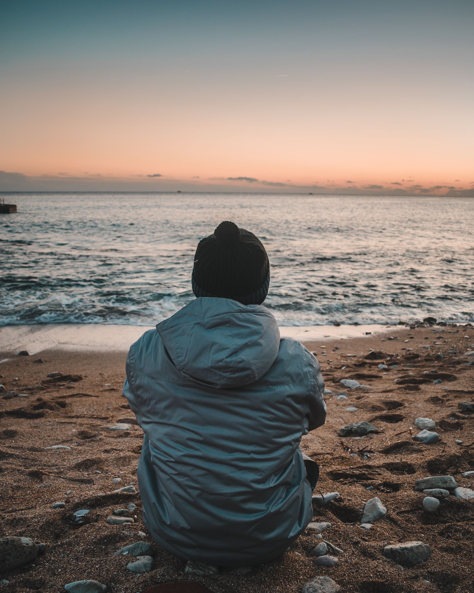 A Person Sitting on a Beach · Free Stock Photo