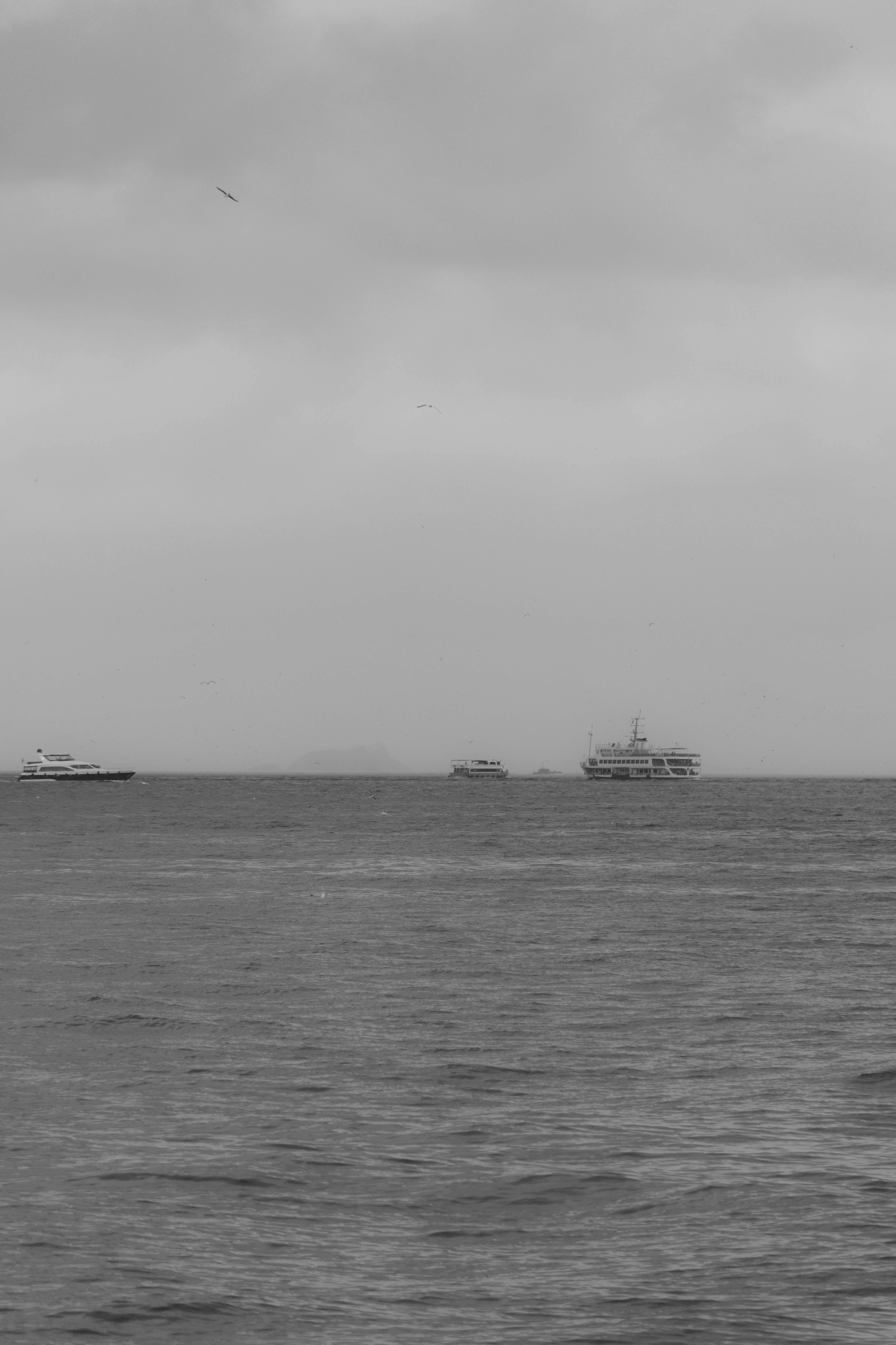 Grayscale Photo of Ships on Sea · Free Stock Photo