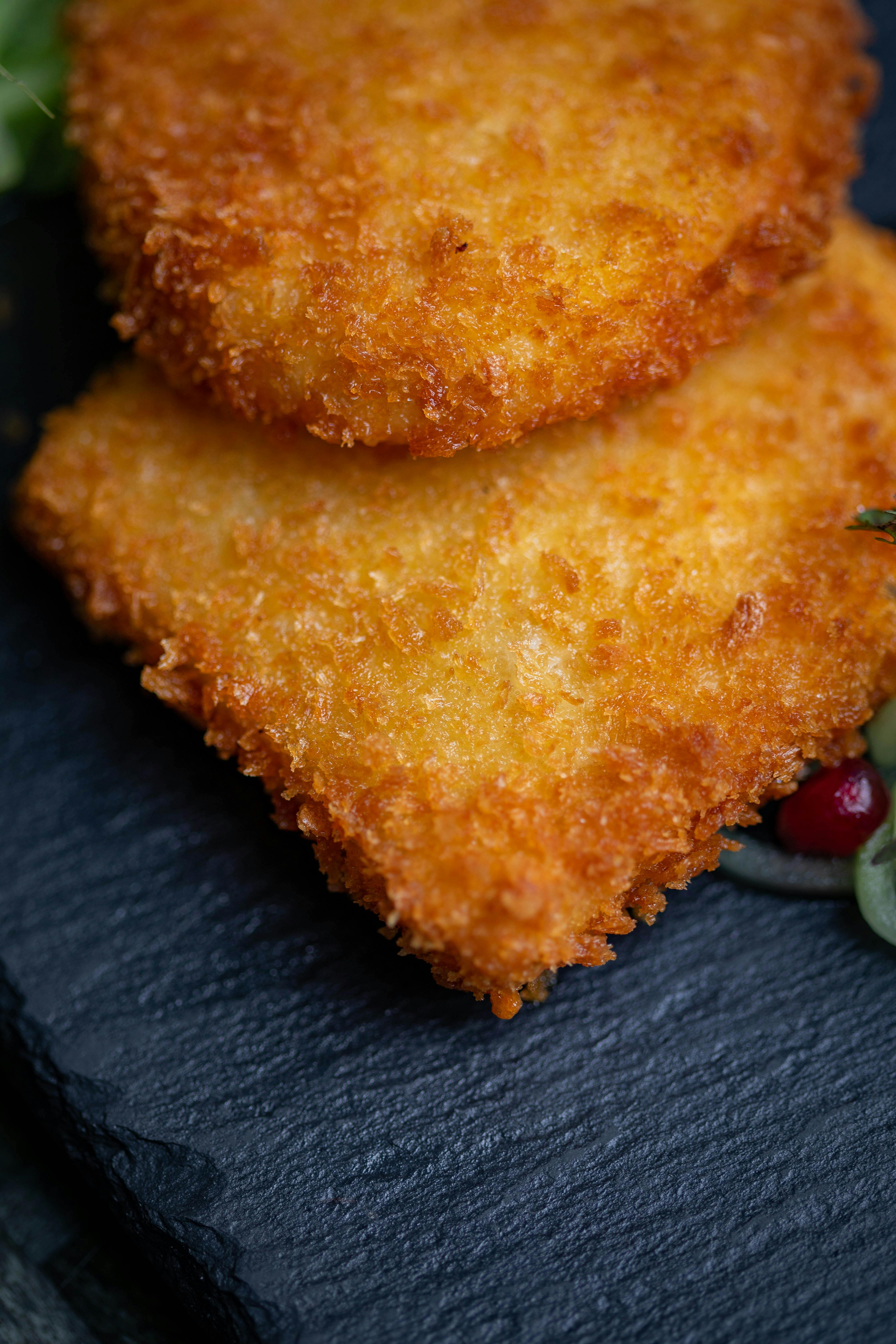 Breaded Food on Black Surface · Free Stock Photo