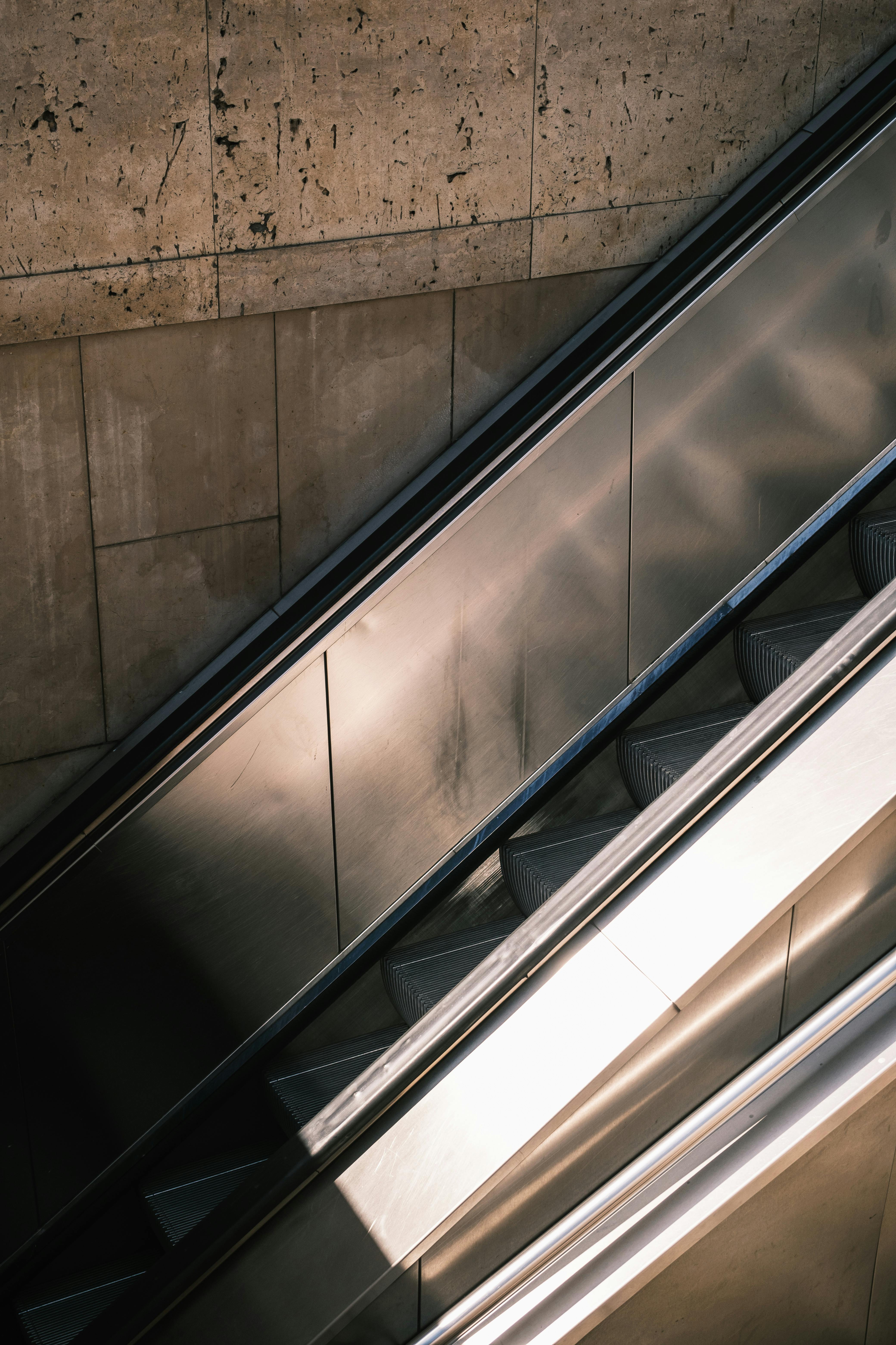 Stainless Steel Escalator Beside Concrete Wall · Free Stock Photo