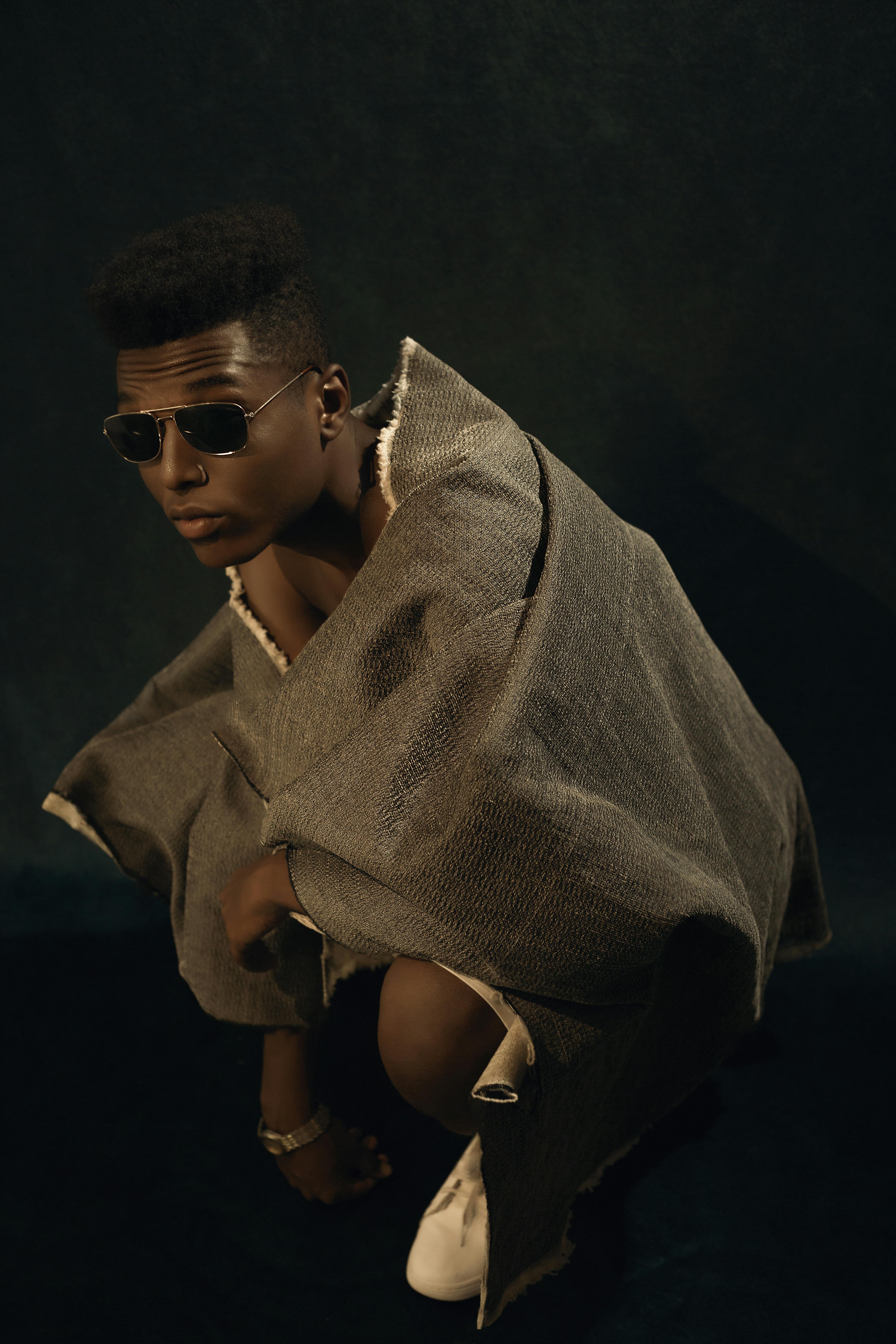 Cool Man in Sunglasses Posing with Headphones in Studio · Free Stock Photo