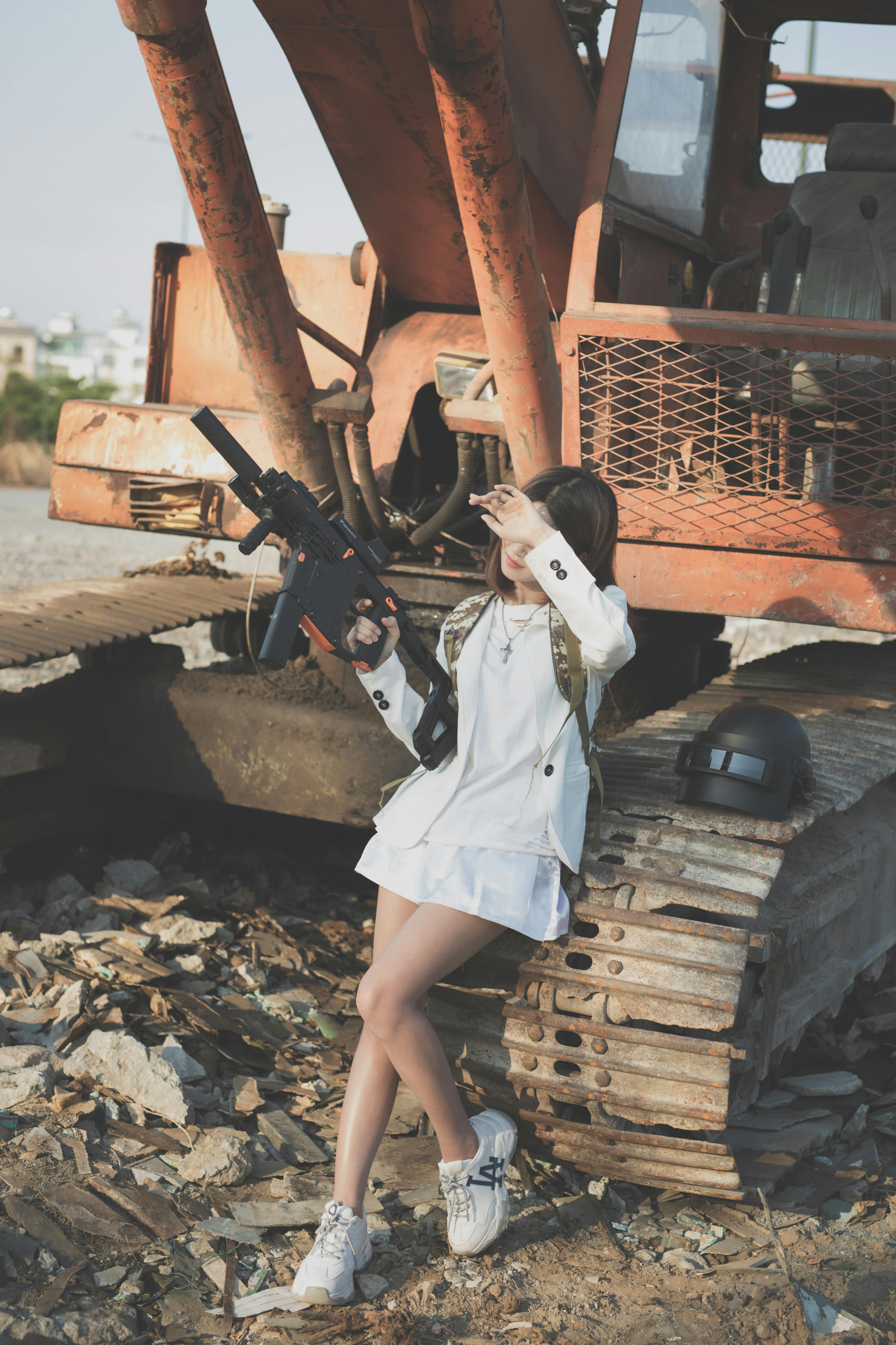 Woman Holding a Machine Gun · Free Stock Photo