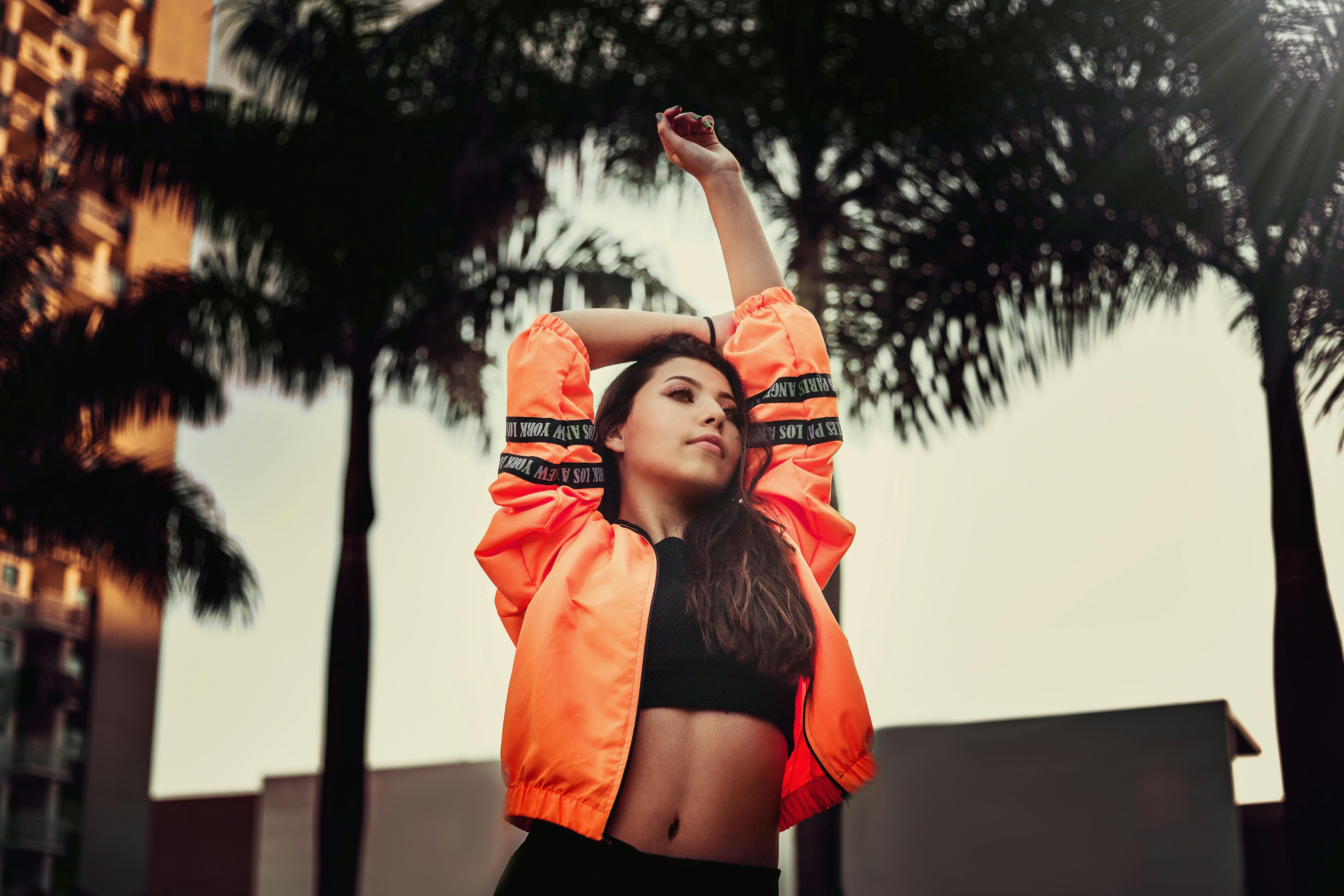 Woman Wearing an Orange Jacket Posing · Free Stock Photo