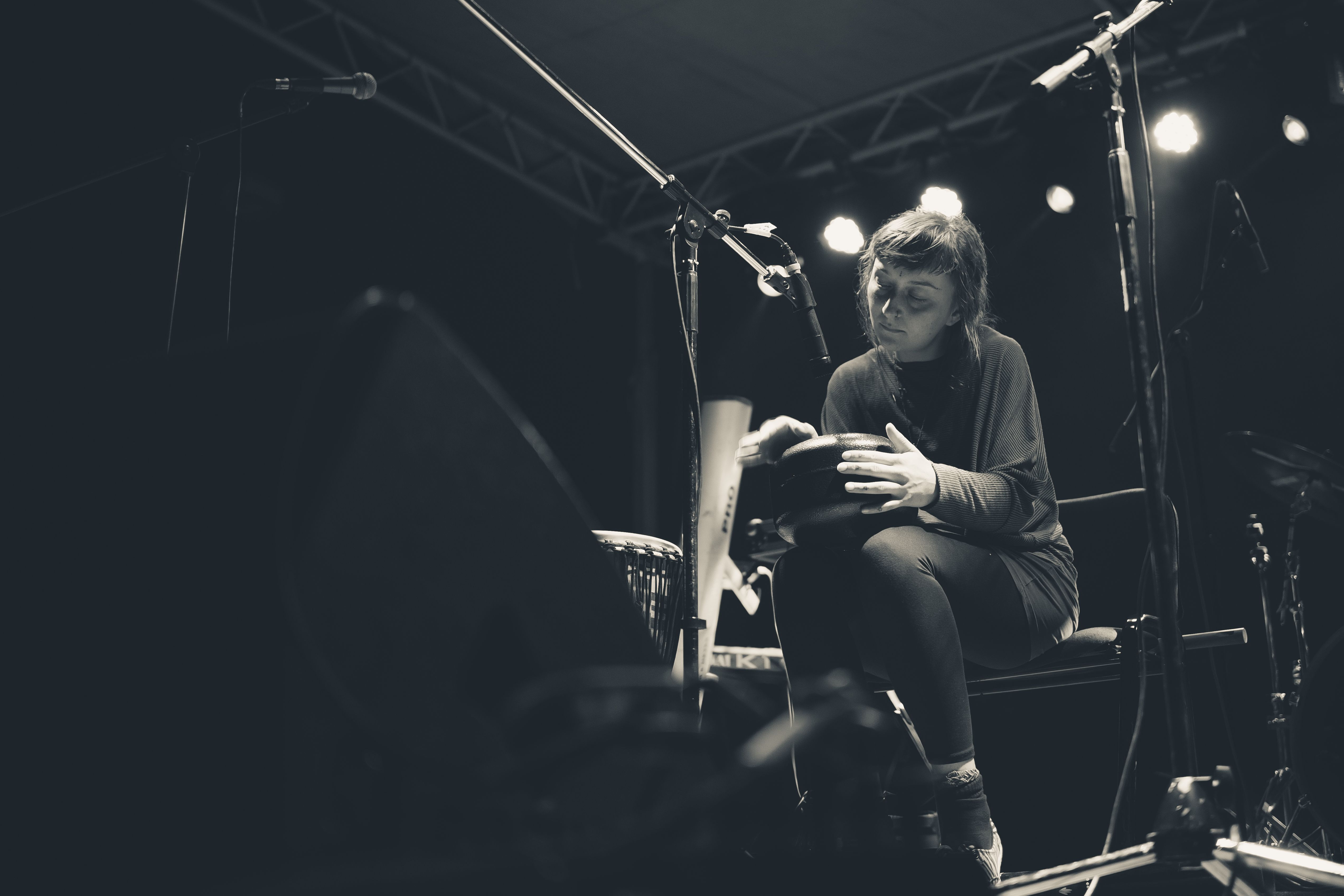 A Woman Posing while Holding a Microphone · Free Stock Photo