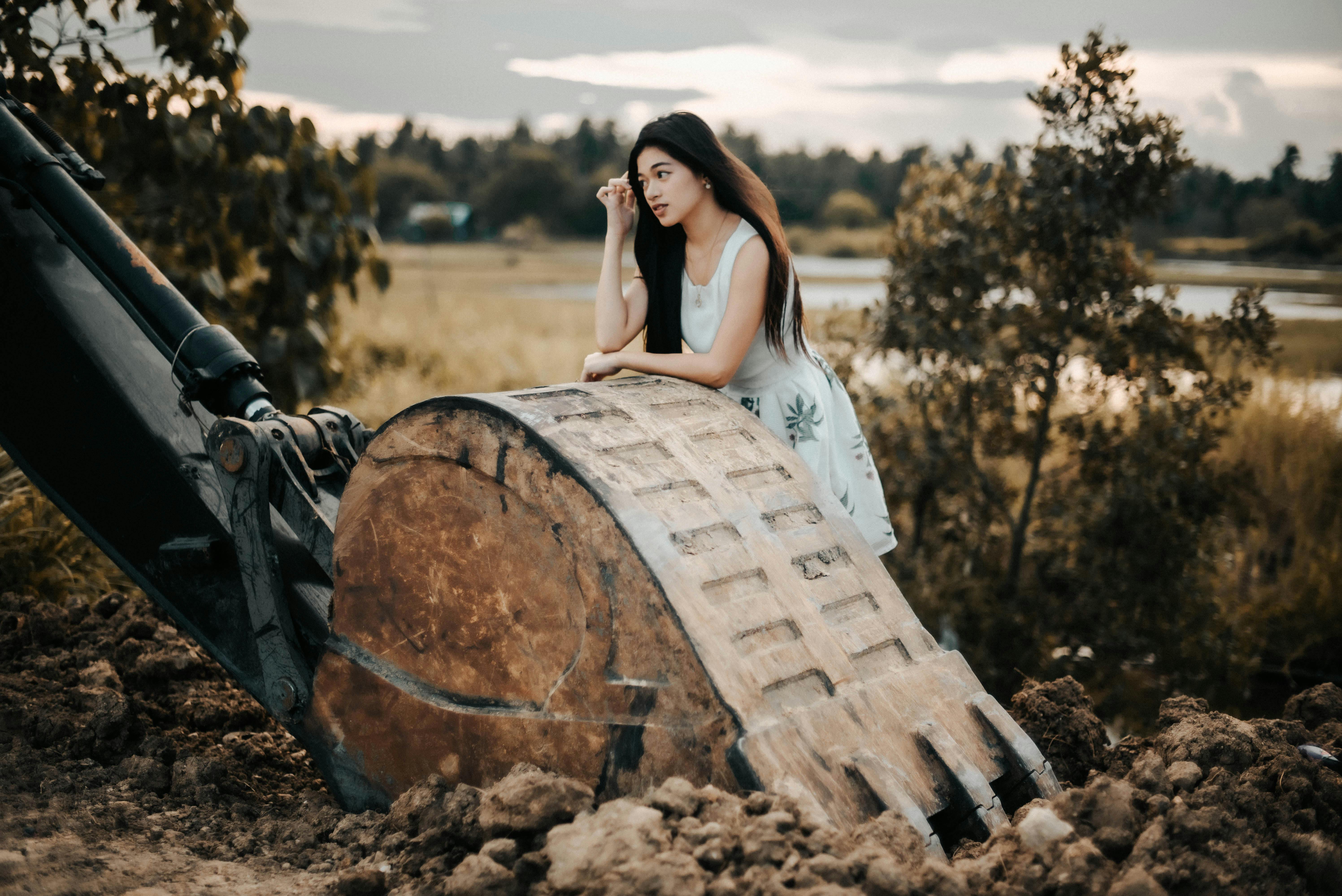 Woman Leaning on Excavator · Free Stock Photo