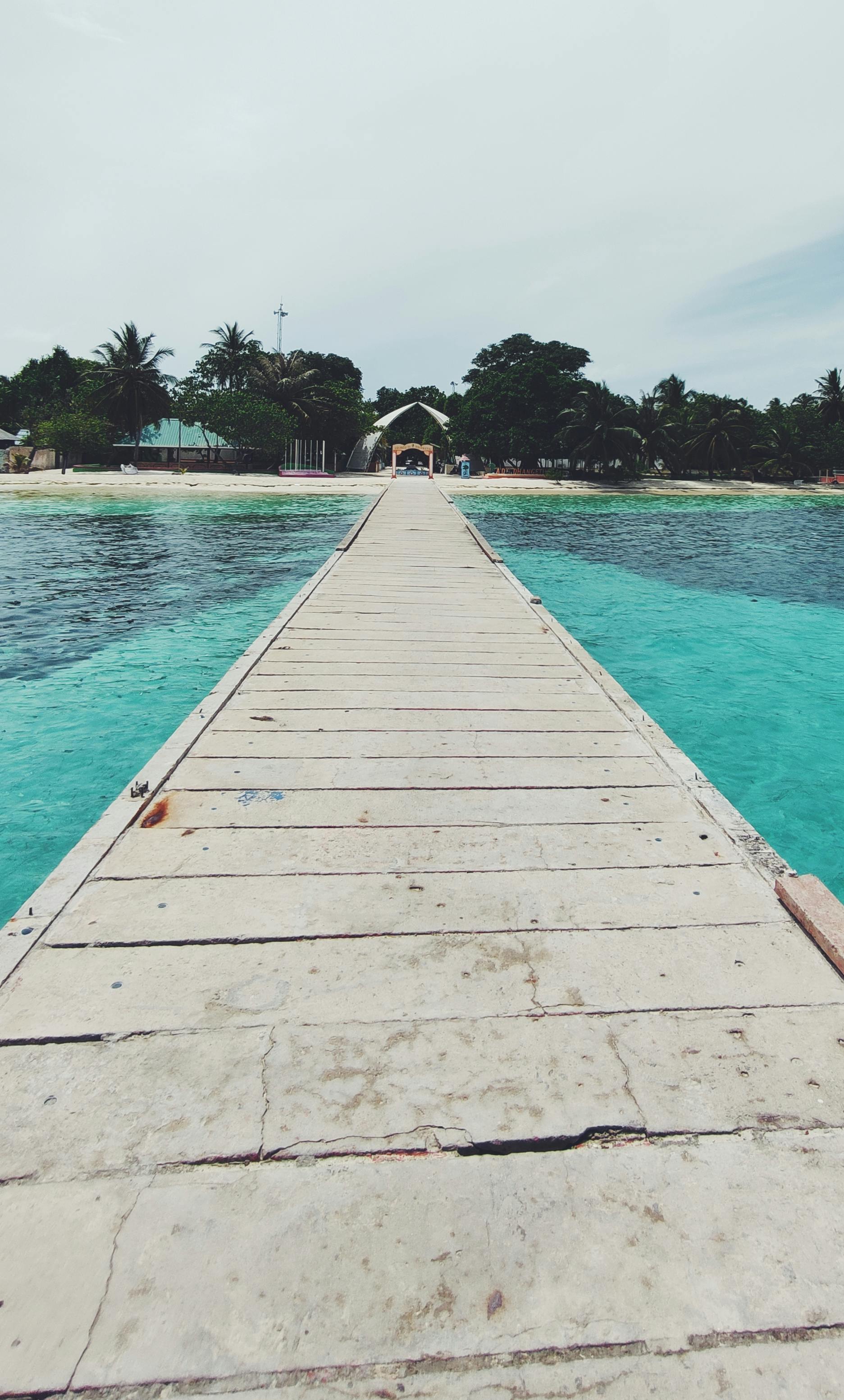 Wooden Jetty in a Sea with Tropical Beach in the Background · Free ...