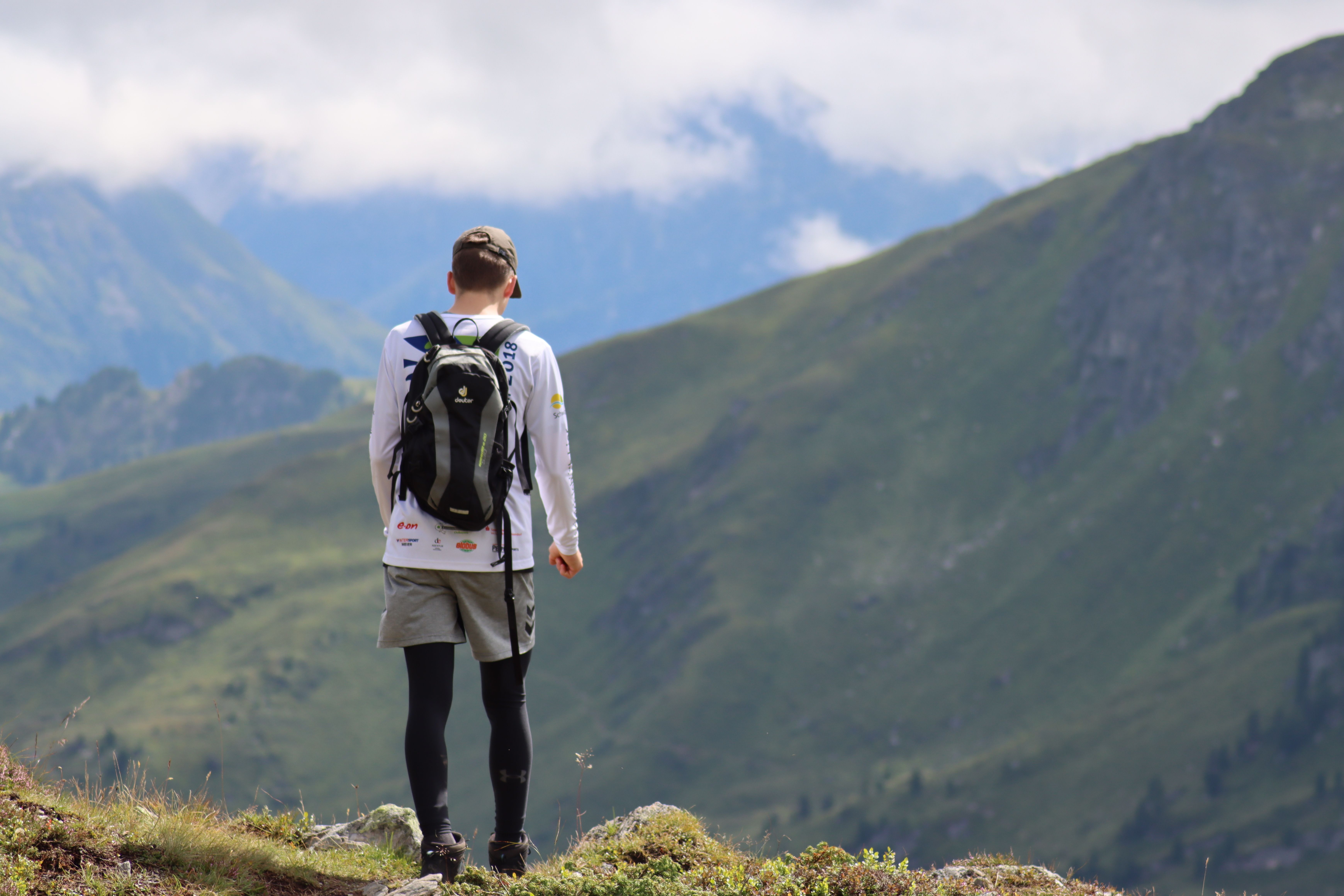Back View of a Man Carrying a Backpack Standing Near Waterfalls · Free ...