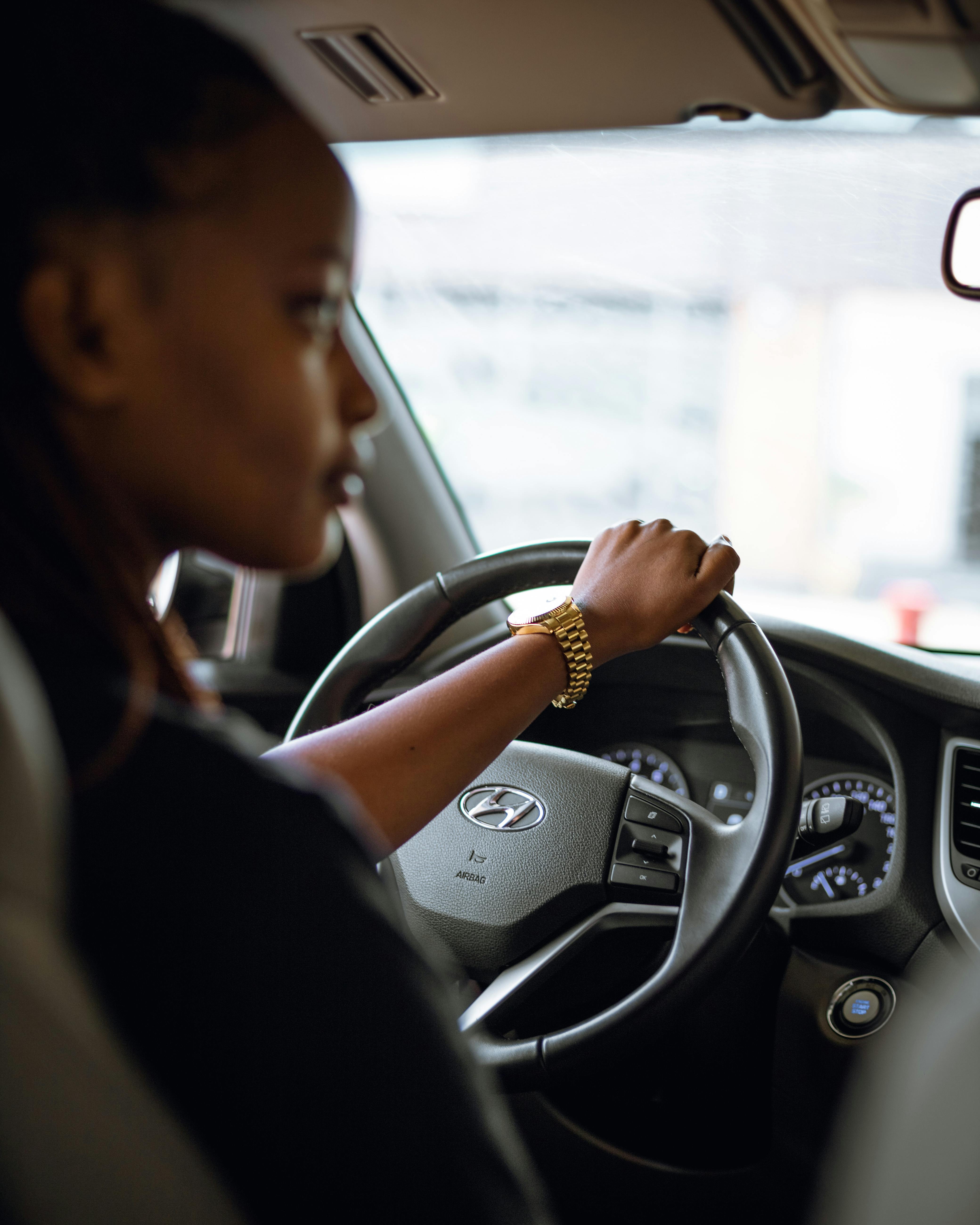 Woman Wearing Gold Watch Driving a Car · Free Stock Photo