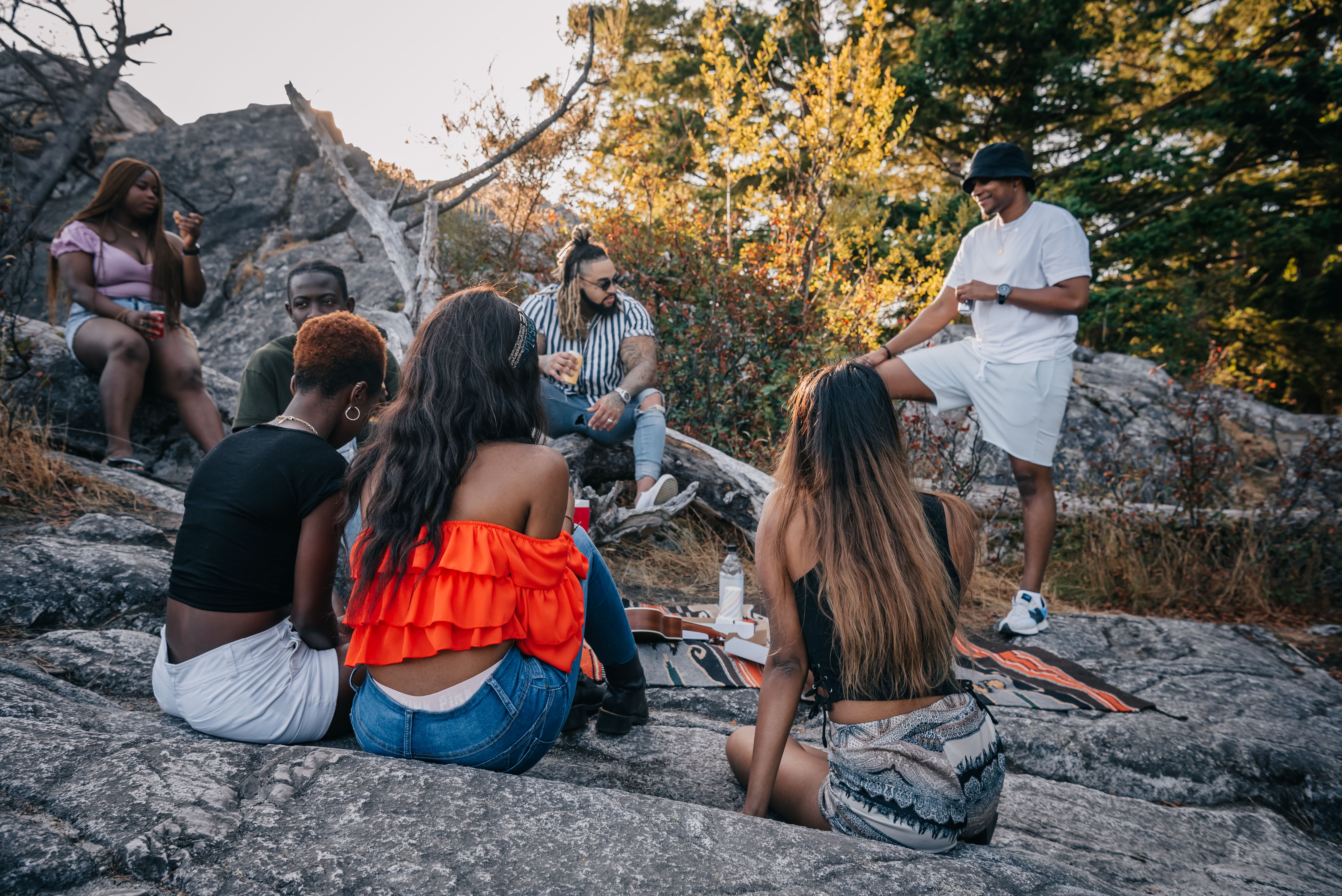 Friends Sitting on Rocks · Free Stock Photo