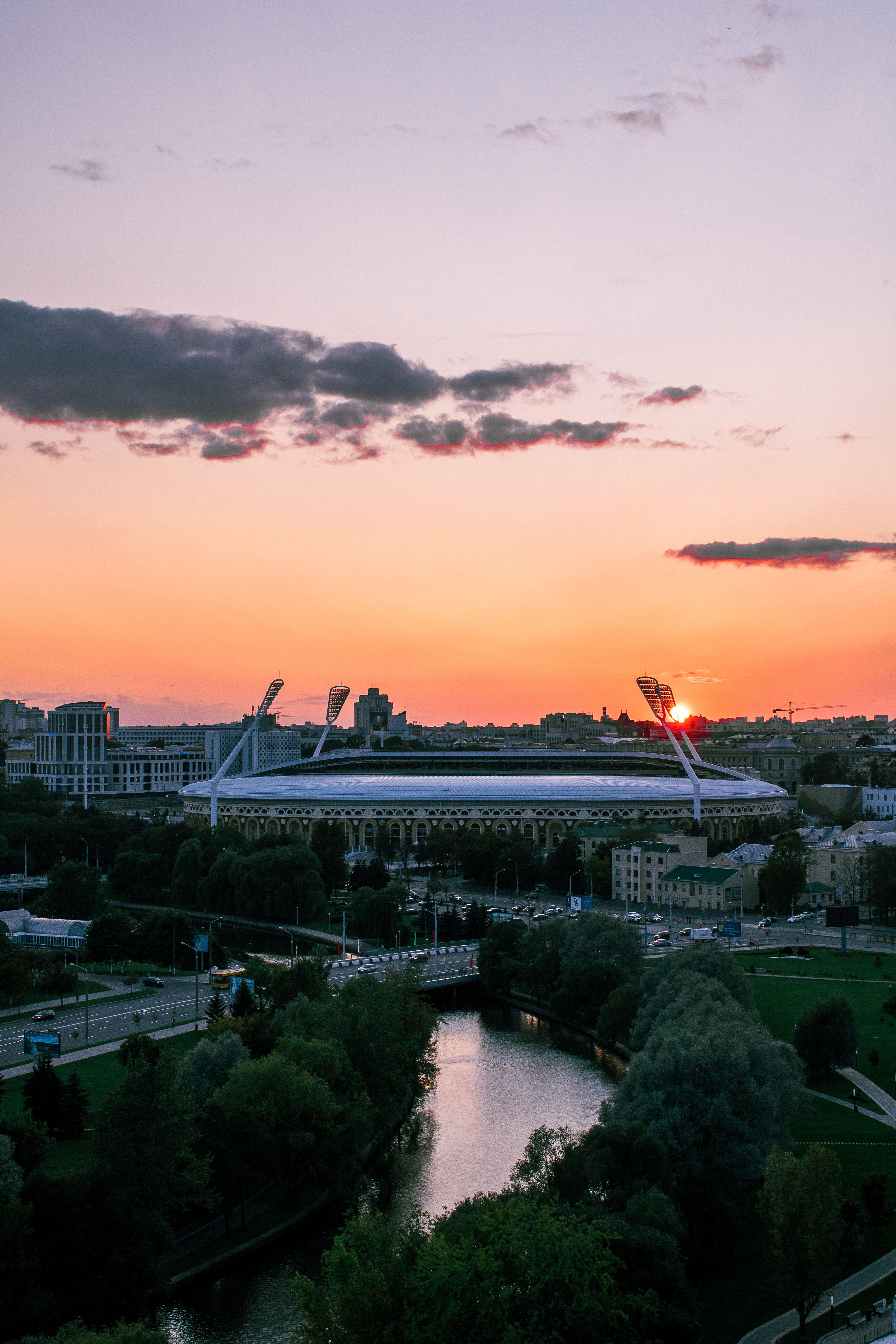 A Stadium Near a Body of Water at Sunset · Free Stock Photo