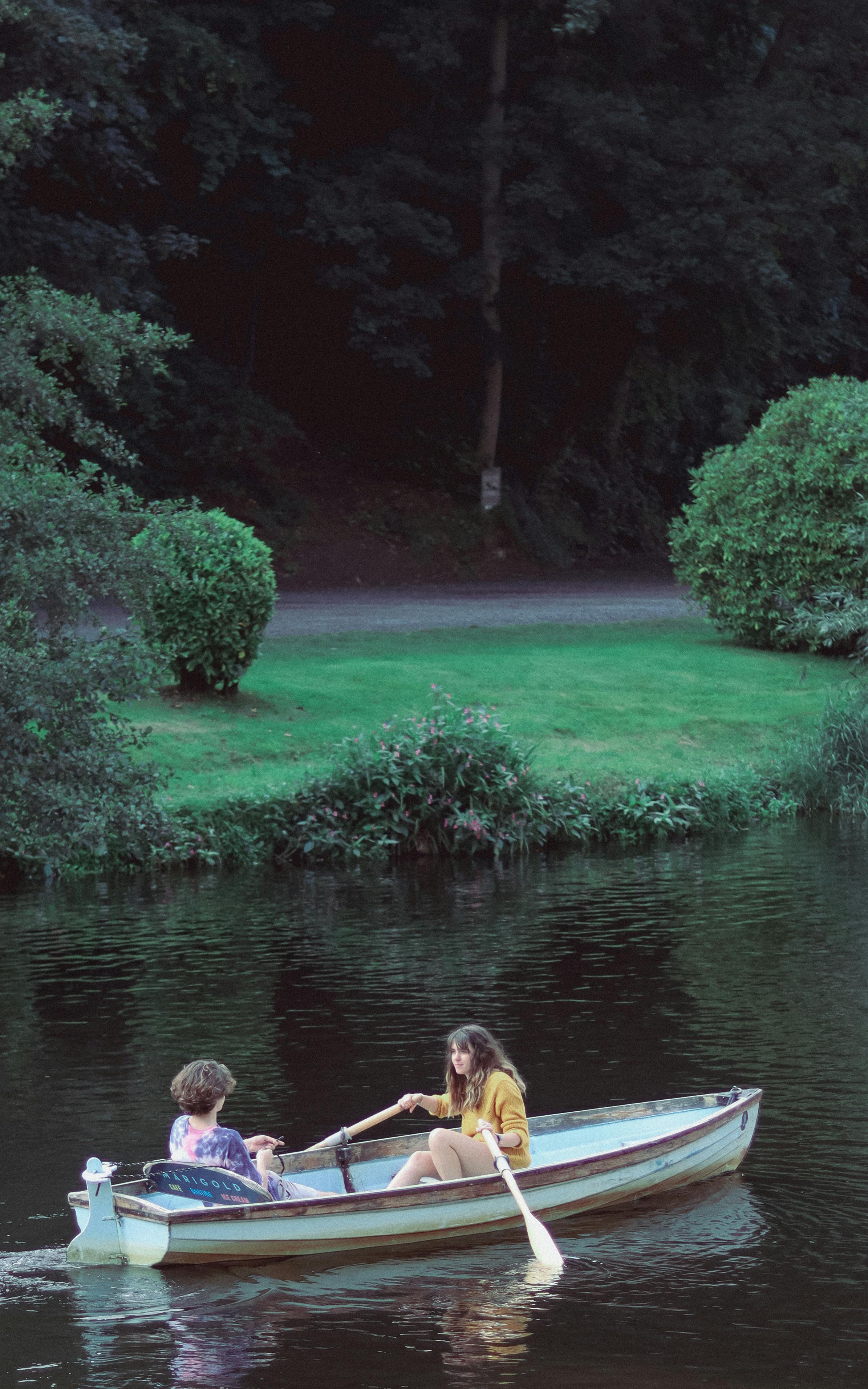 Two Men Sitting on Riverbank · Free Stock Photo