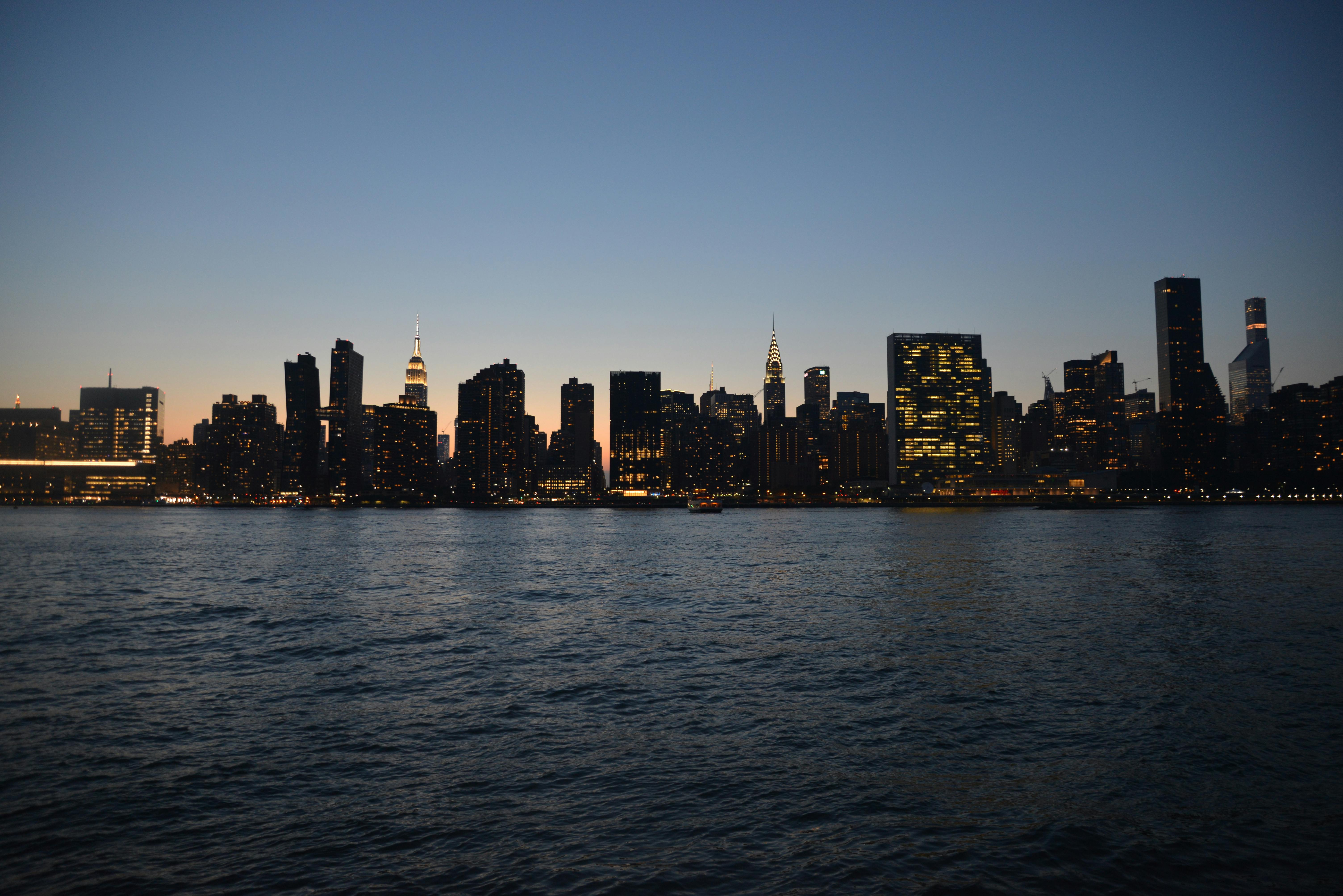 View of Lighted City Near Water at Night · Free Stock Photo