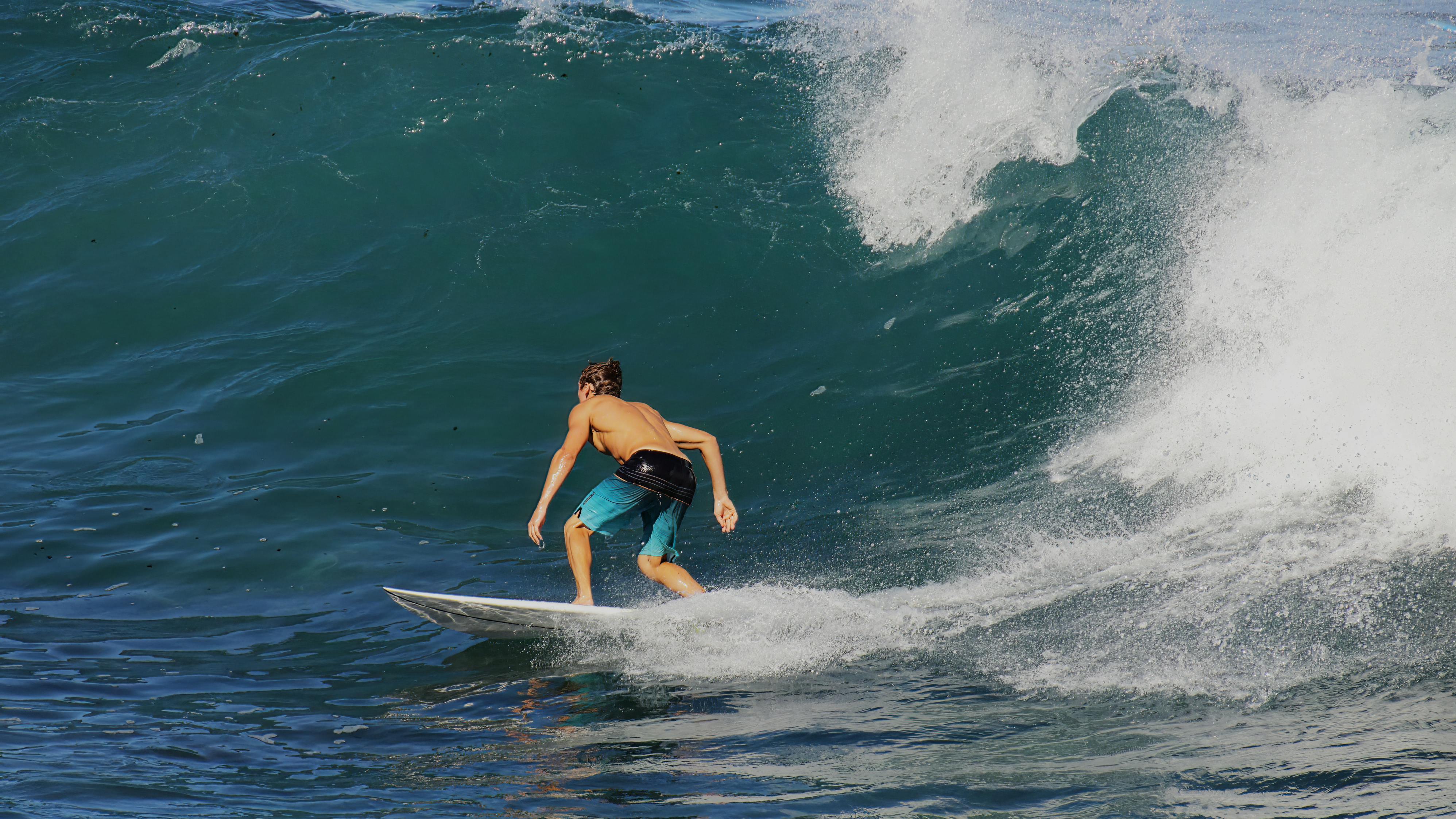 Grayscale Photo of a Shirtless Man Surfing on Sea Waves · Free Stock Photo