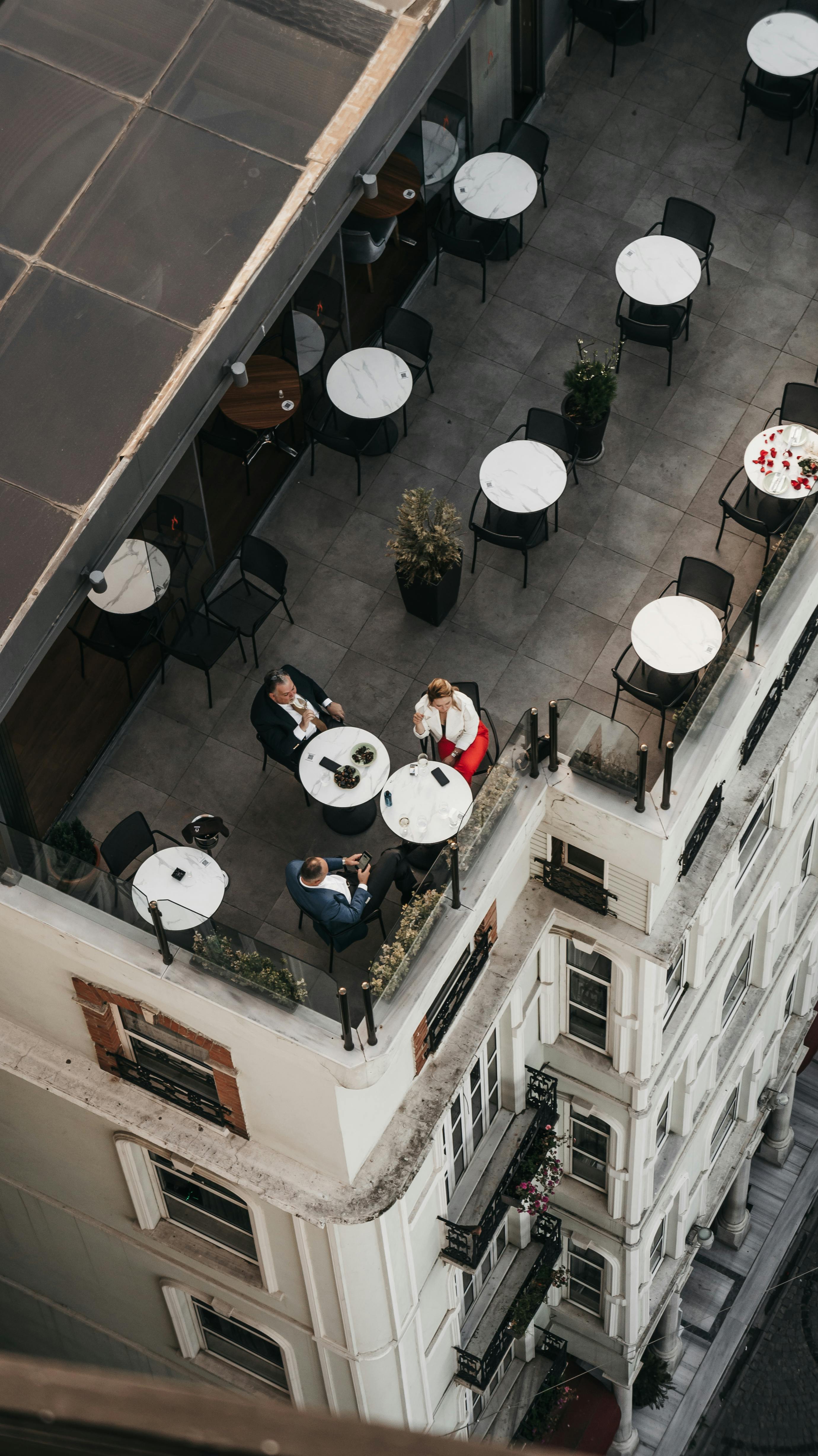 People Sitting on Chairs on a Rooftop · Free Stock Photo