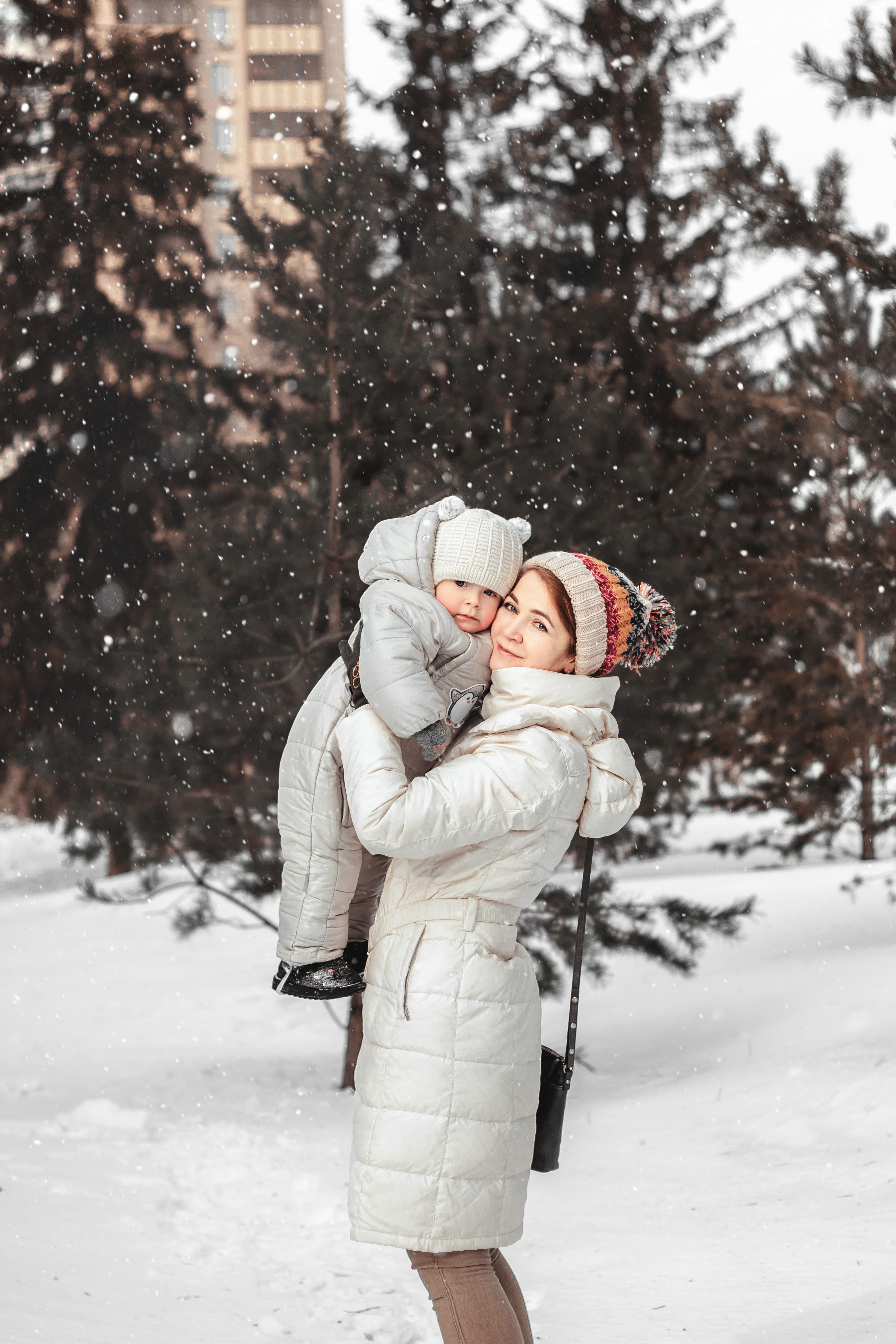 Mother in a Winter Coat Holding her Baby · Free Stock Photo