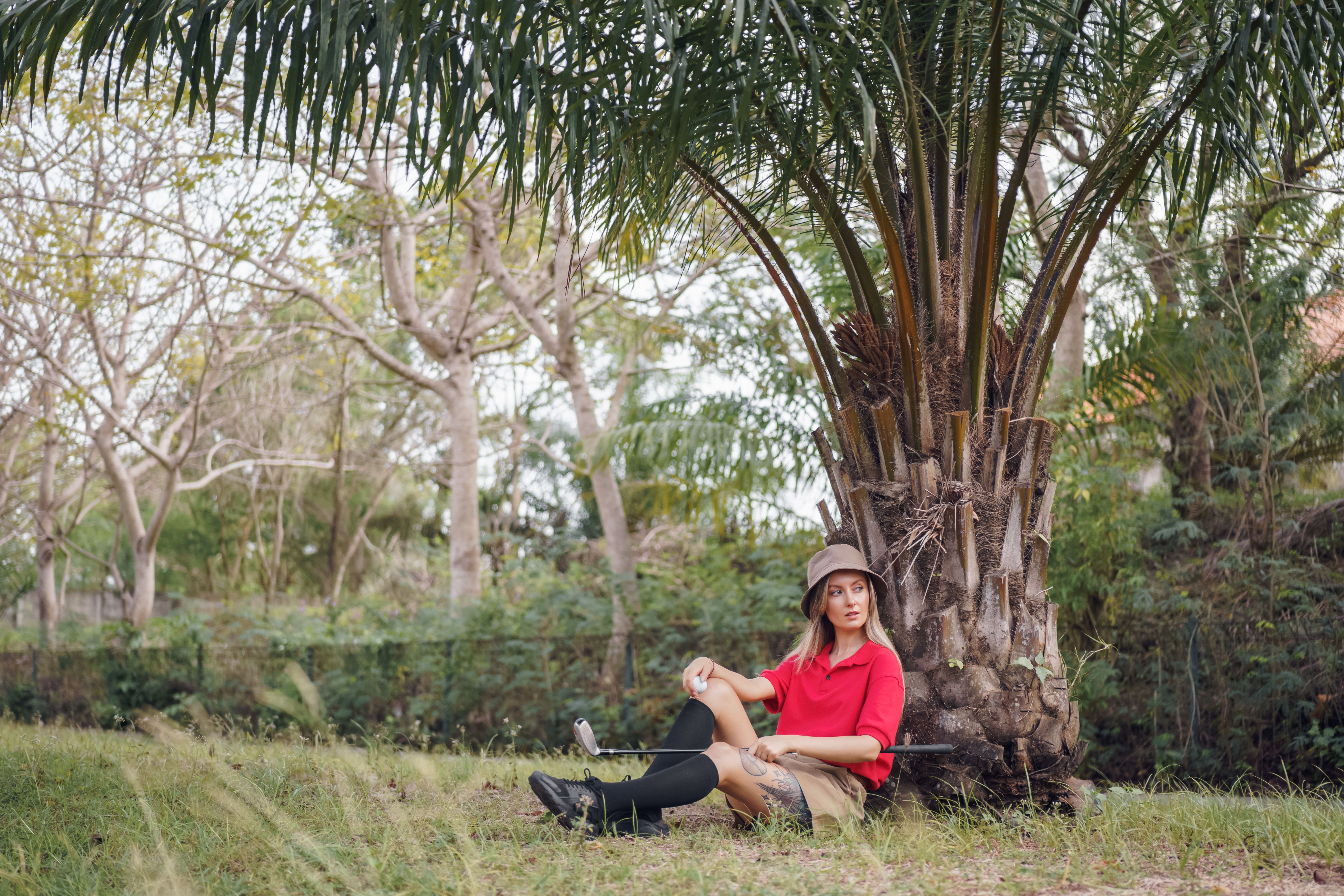 Woman Sitting under a Palm Tree · Free Stock Photo
